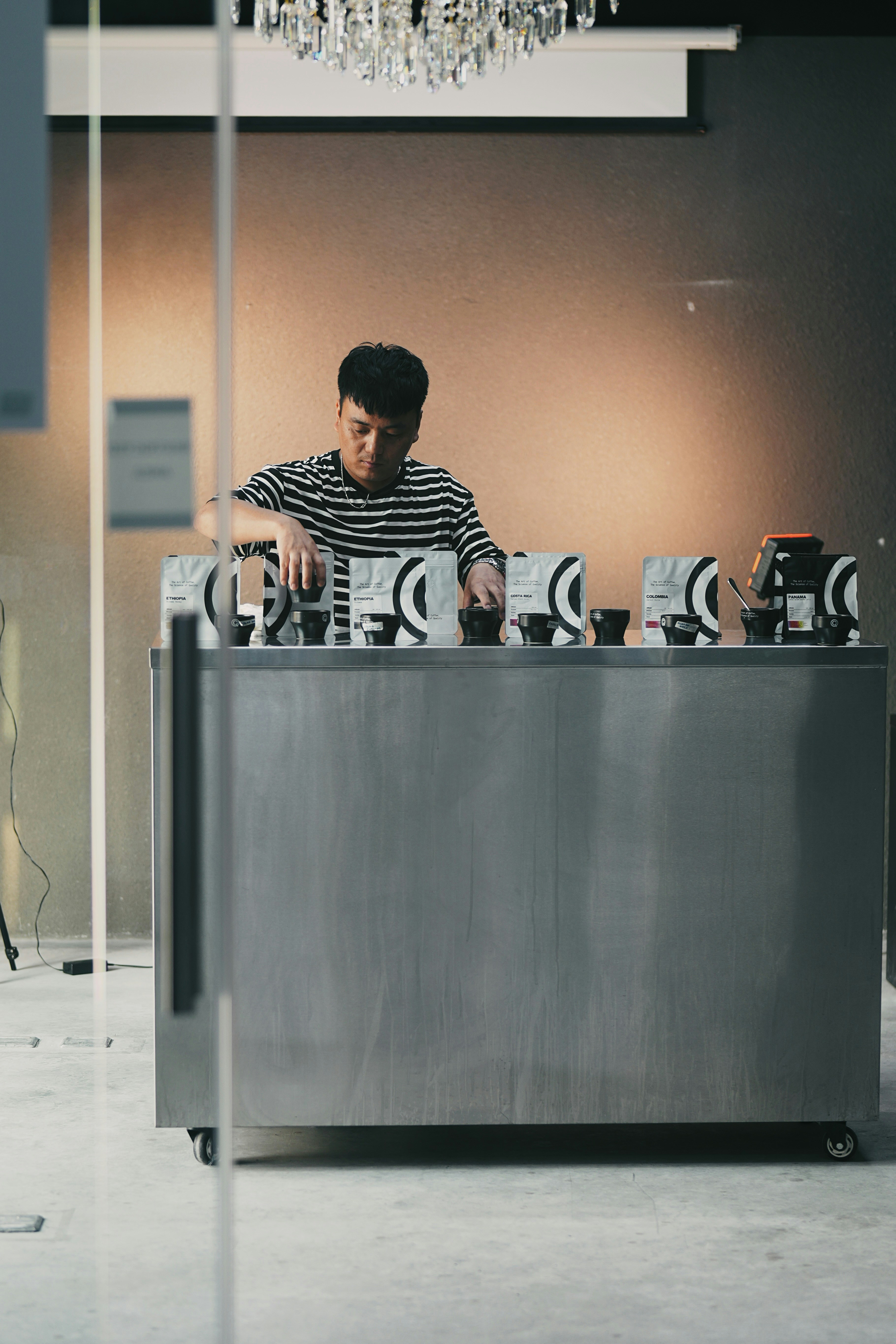 Striped shirt, stainless counter: a quiet moment behind the soda-fizzed counter