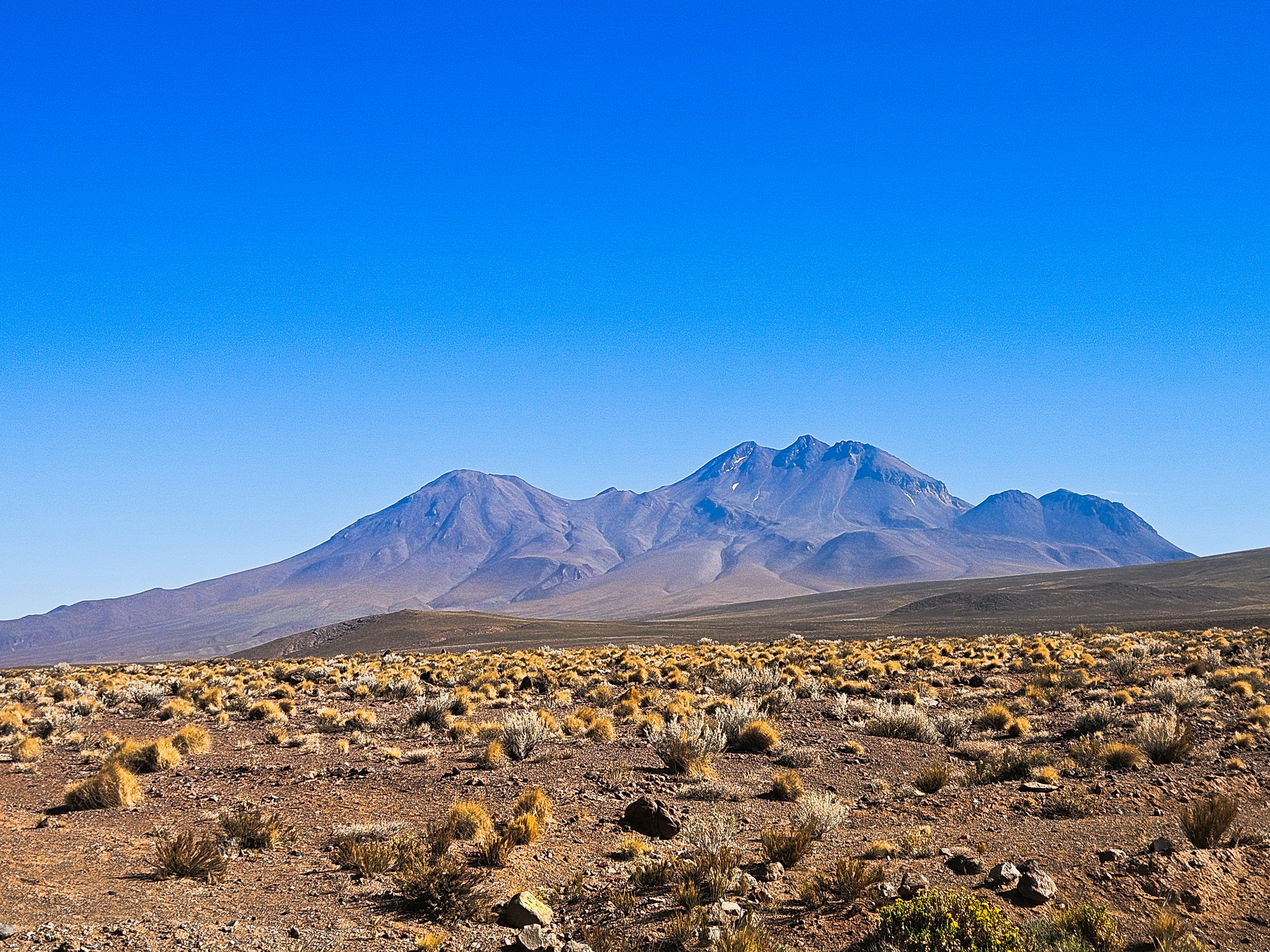 Desert Ridge: A Distant Mountain Canvas Under a Blank Sky