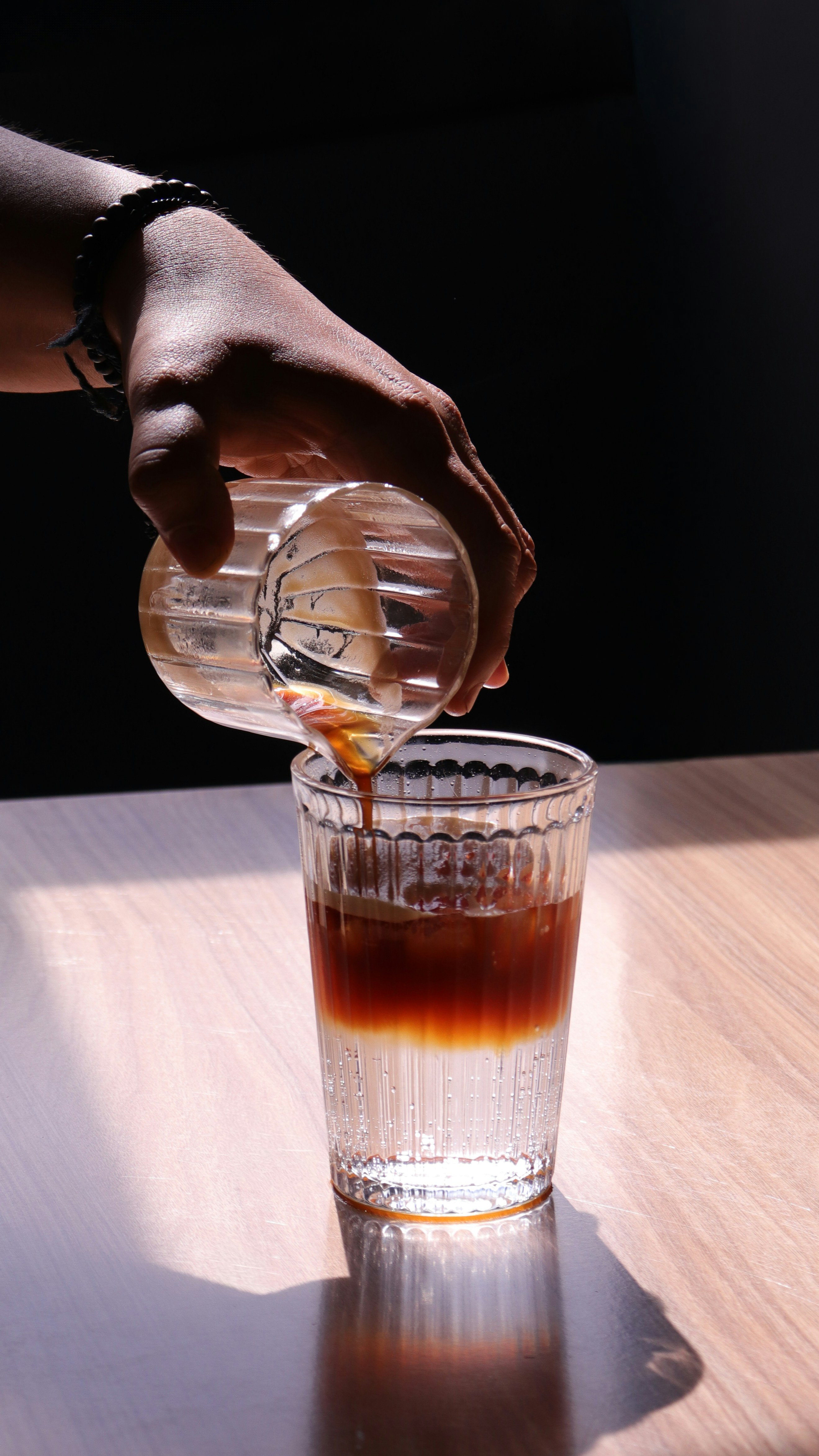 Pour of Precision: A Handbright Pour Captured in Quiet Contrast