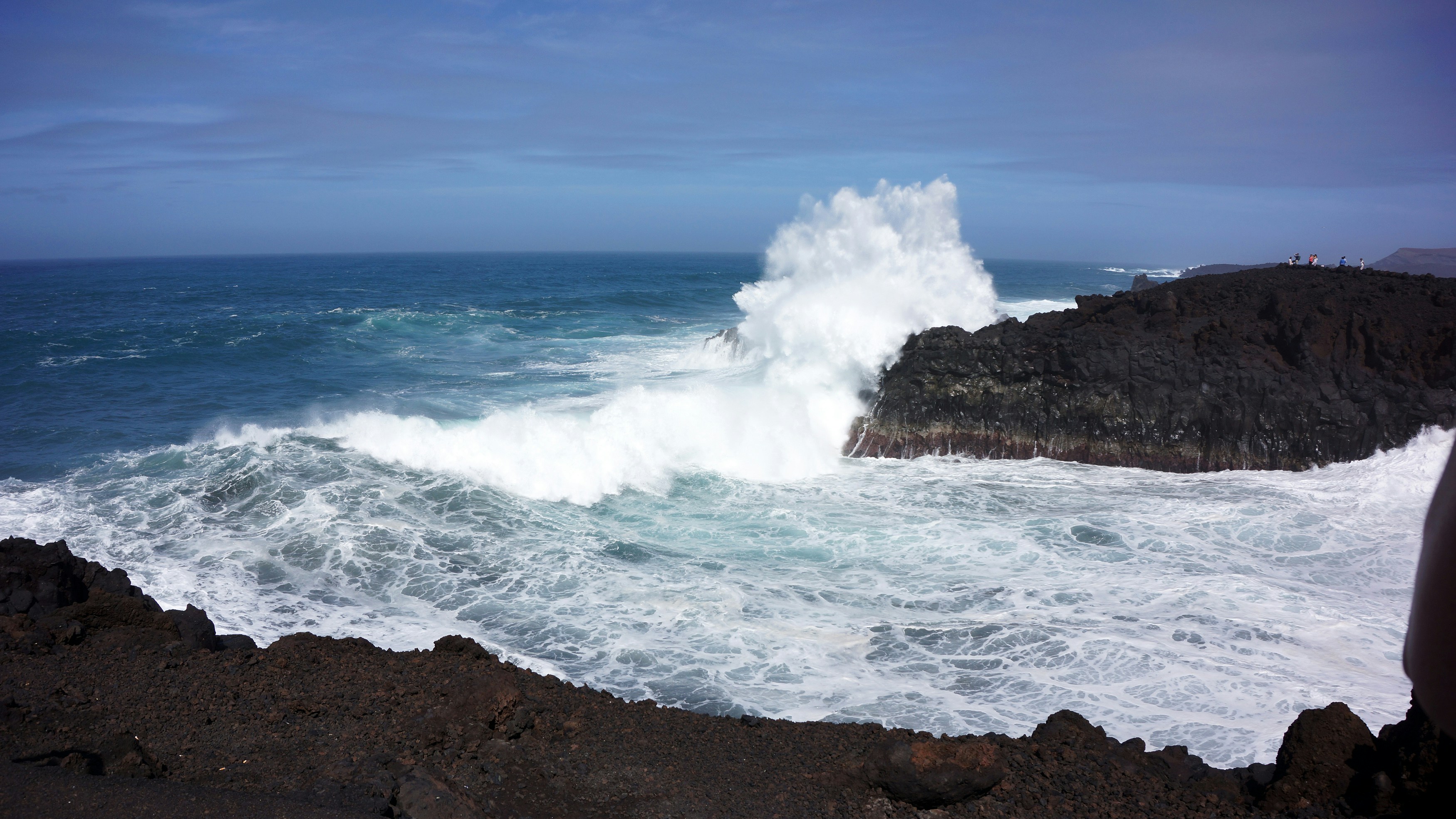Wavebreak Against the Lava Cliff