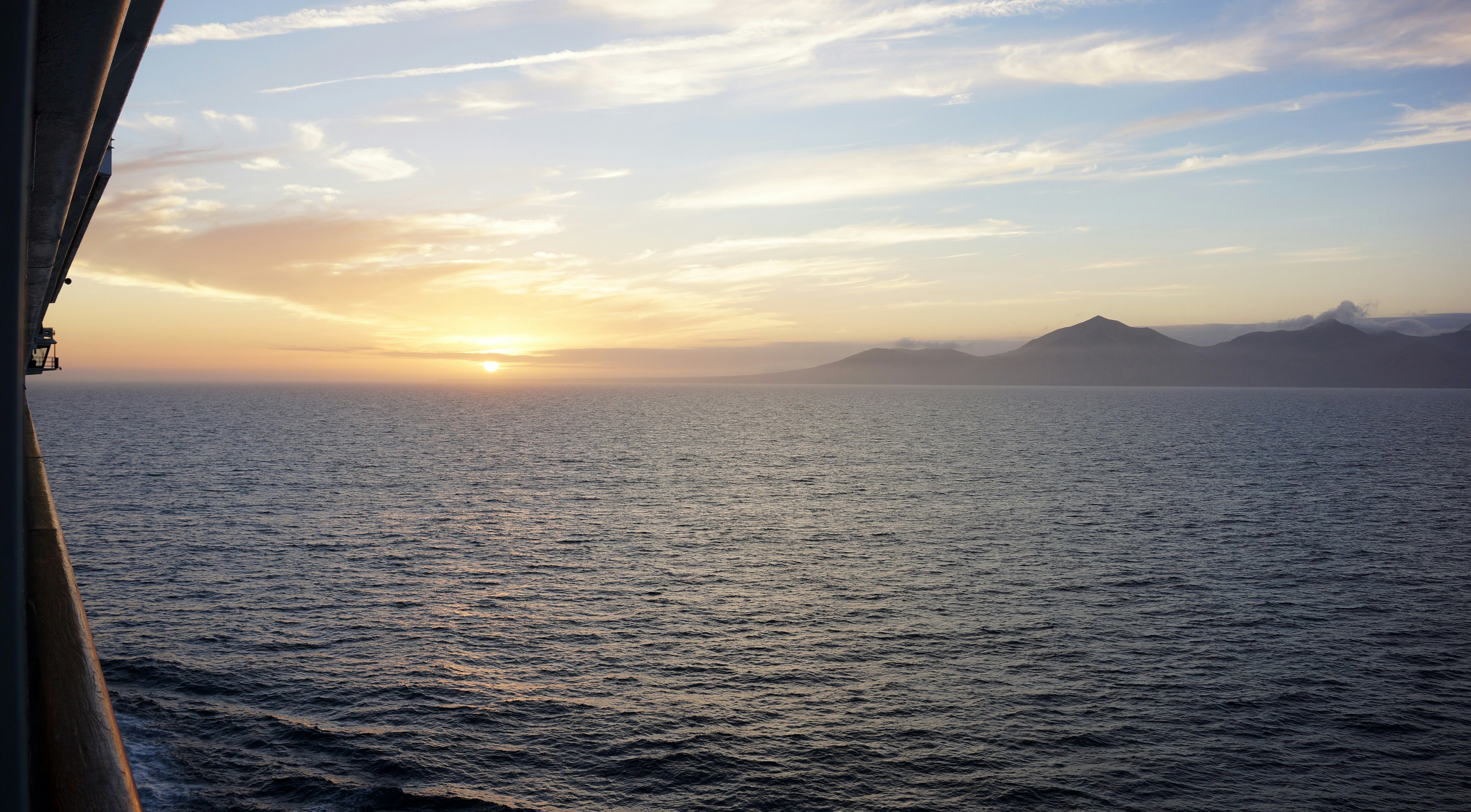 Sunset Over Calm Seas from a Vessel Window