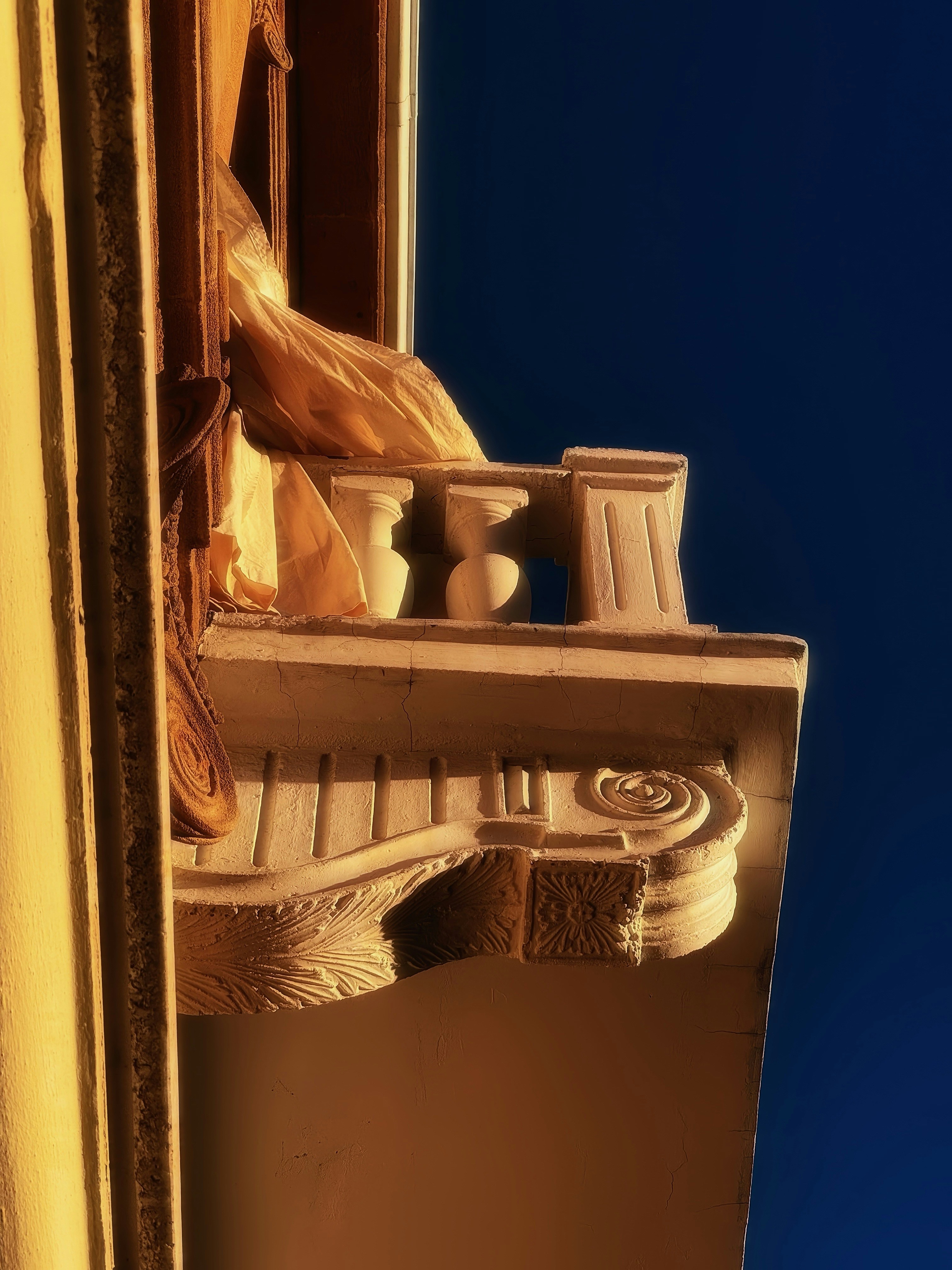 Sunlit Pediment Details on a Classic Cornice