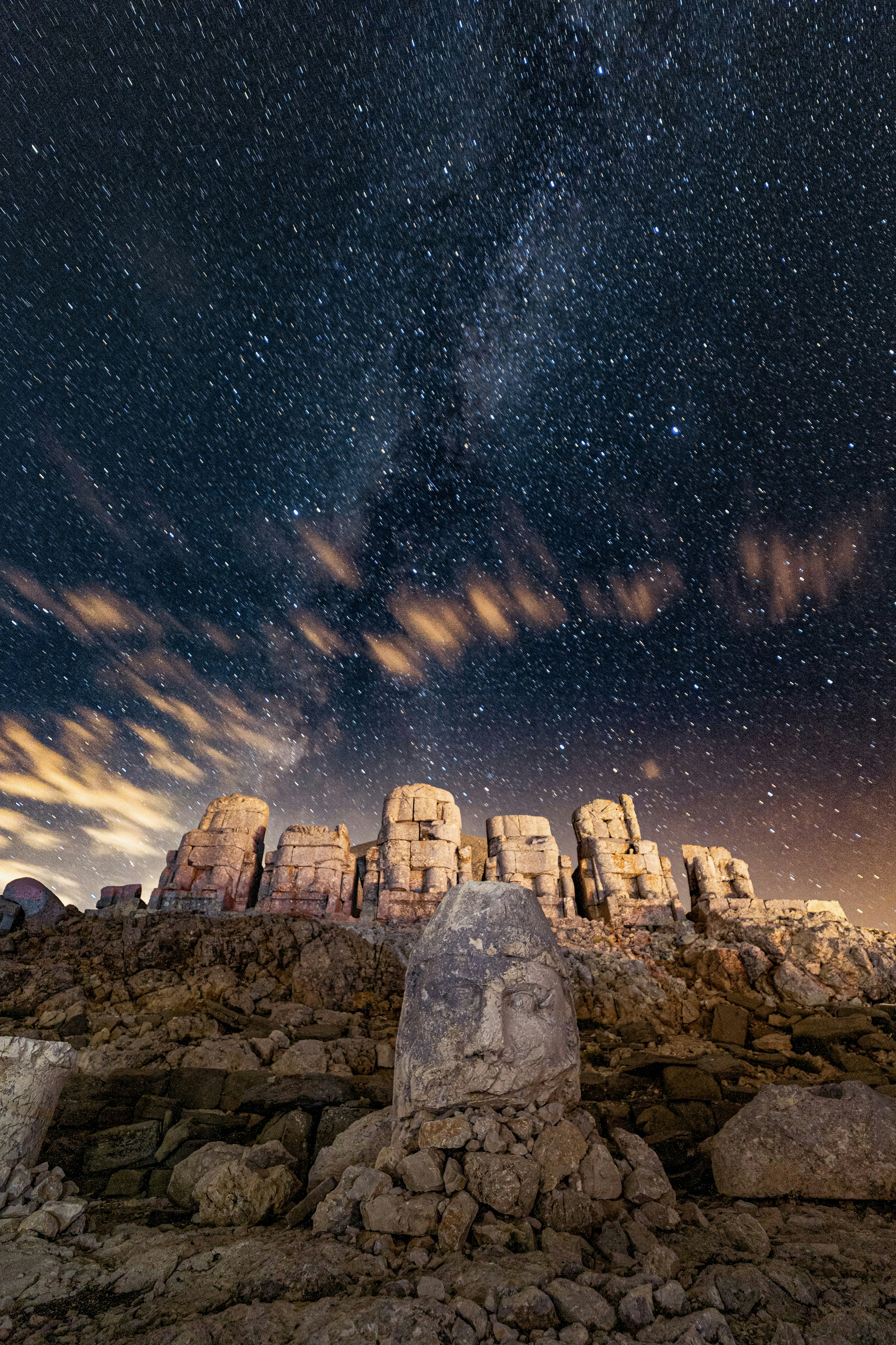 Moonlit Giants: Stone Faces Beneath the Milky Way