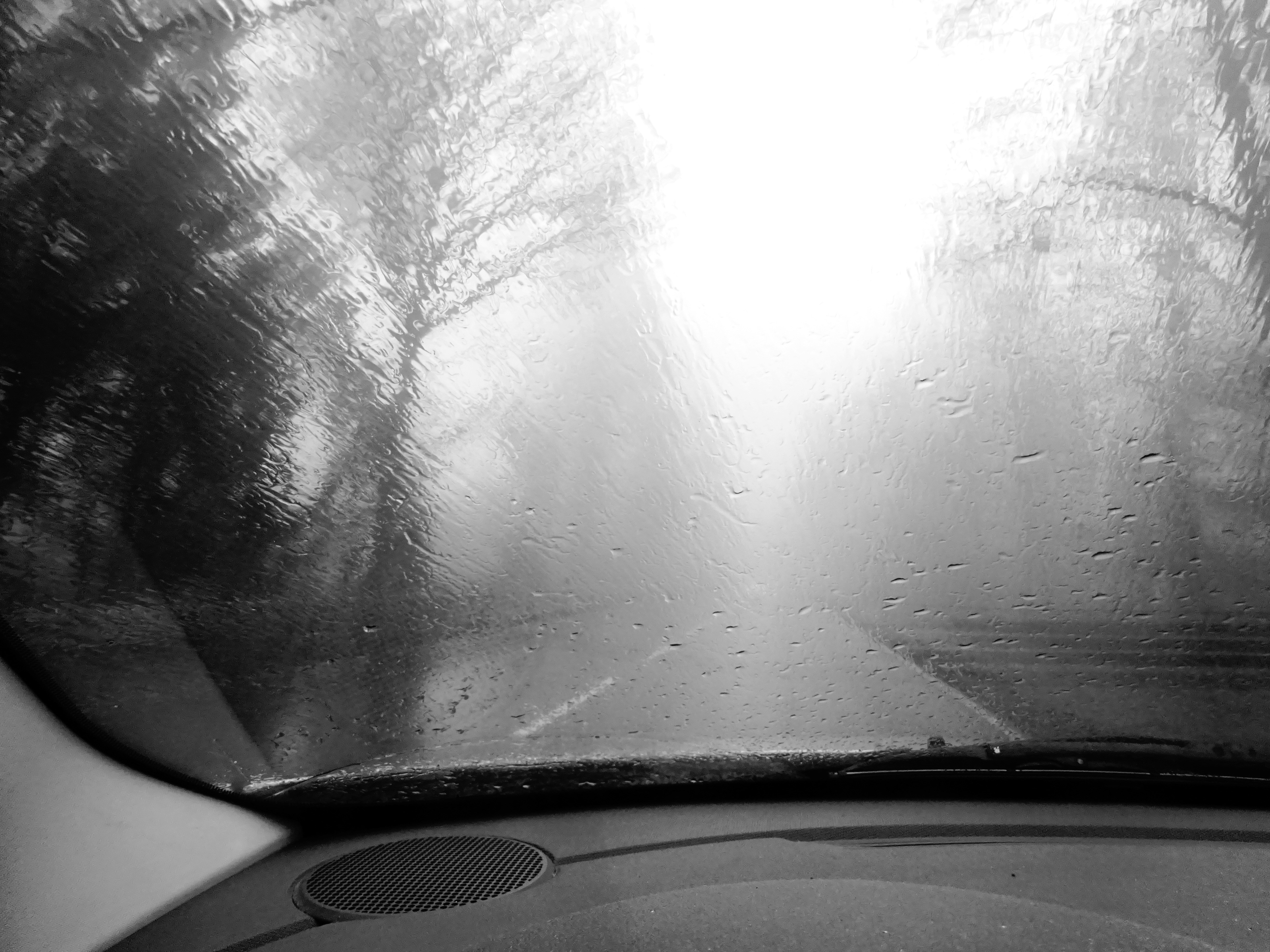 Mist on the Road: Light Piercing Rain Through a car windscreen