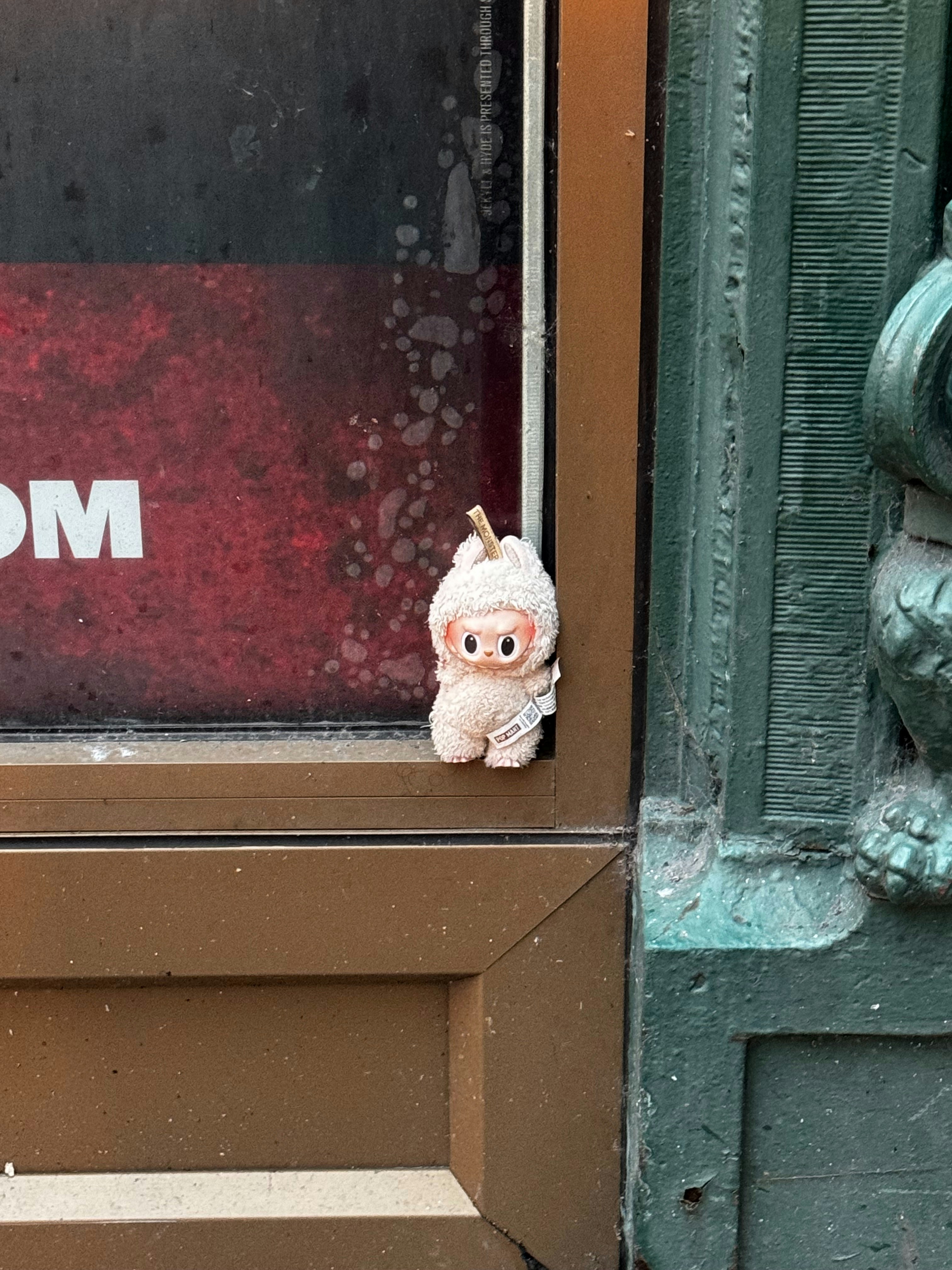 Tiny Plush Guardian at the Doorway