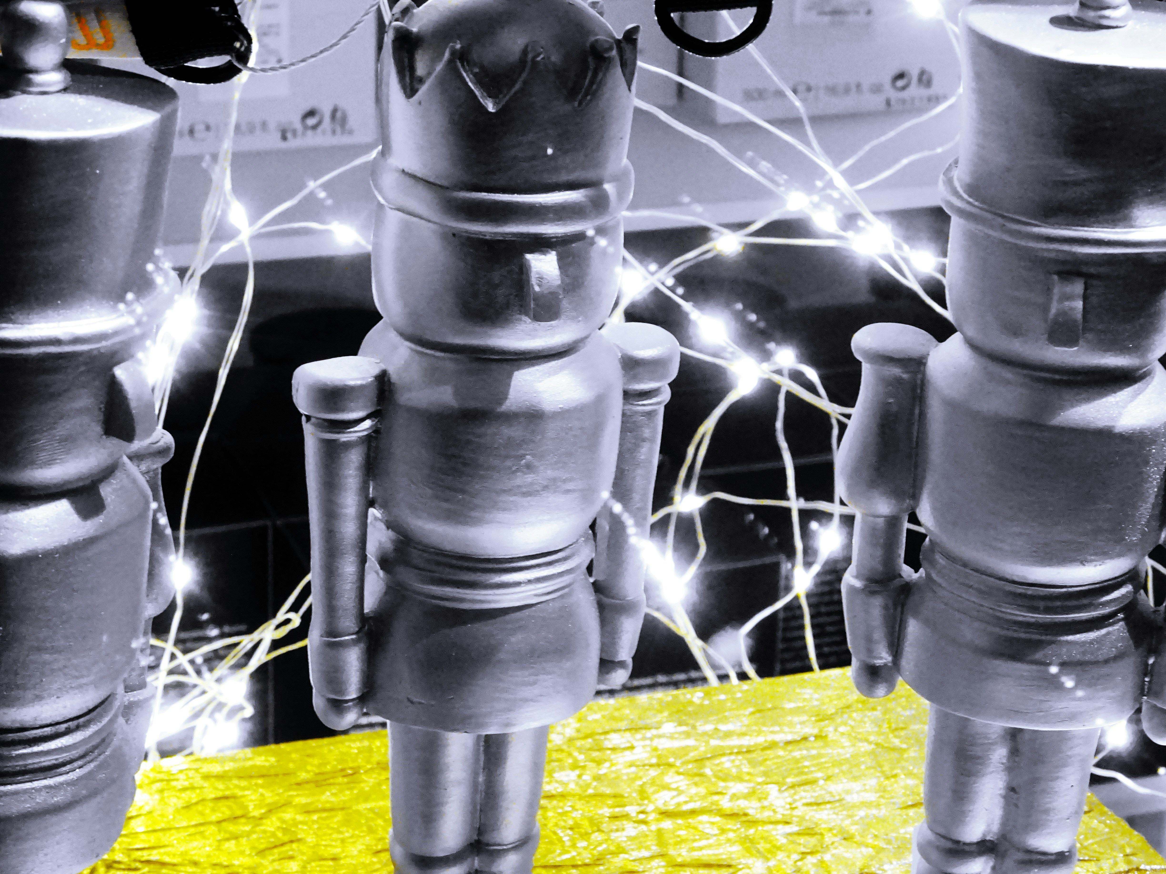 Glowing Guards: A Trio of LEGO-like Sentinels amid Warm Fairy Lights