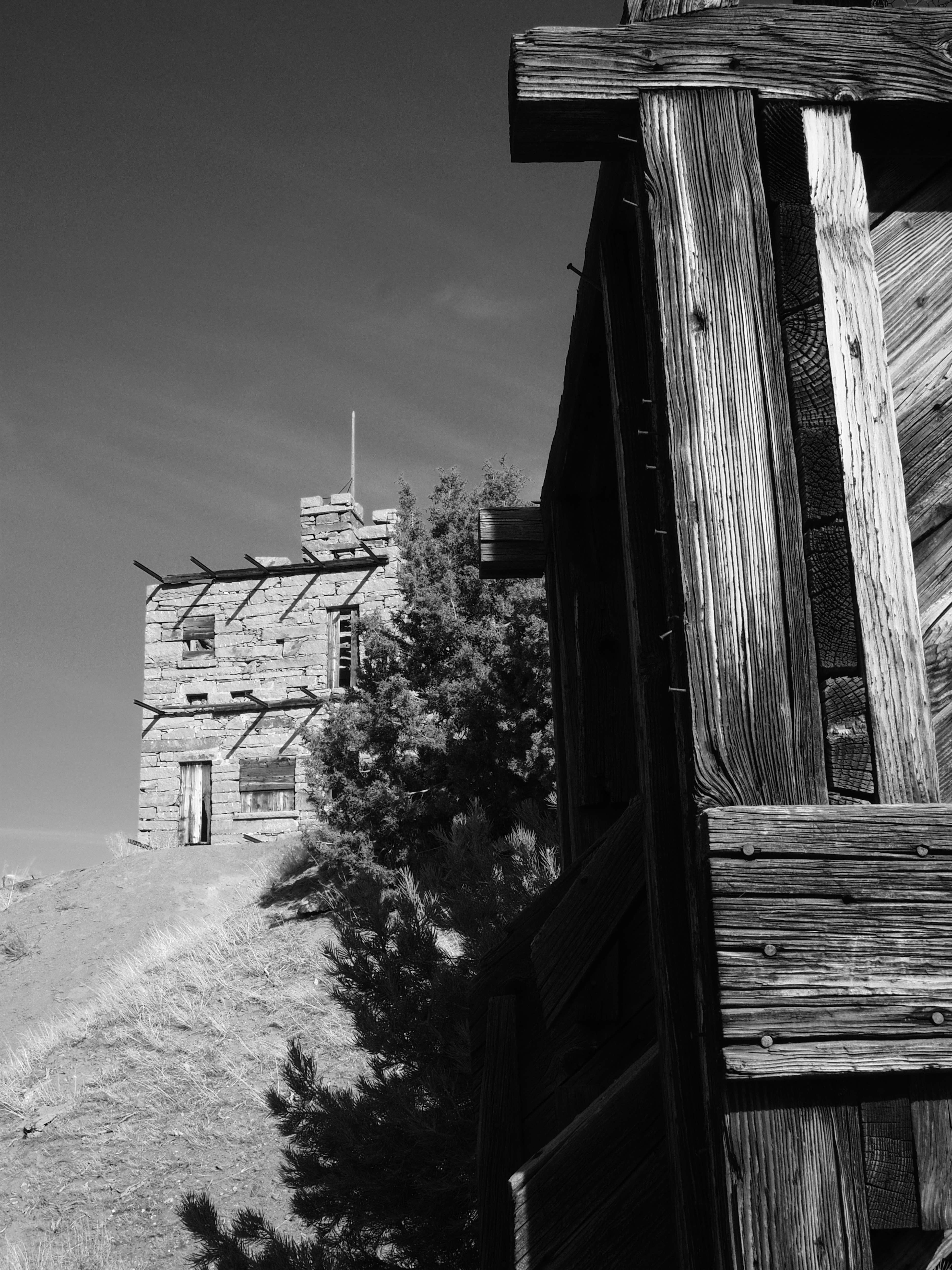 Weathered Watchtower: A Lone Structure Rising from the Slope