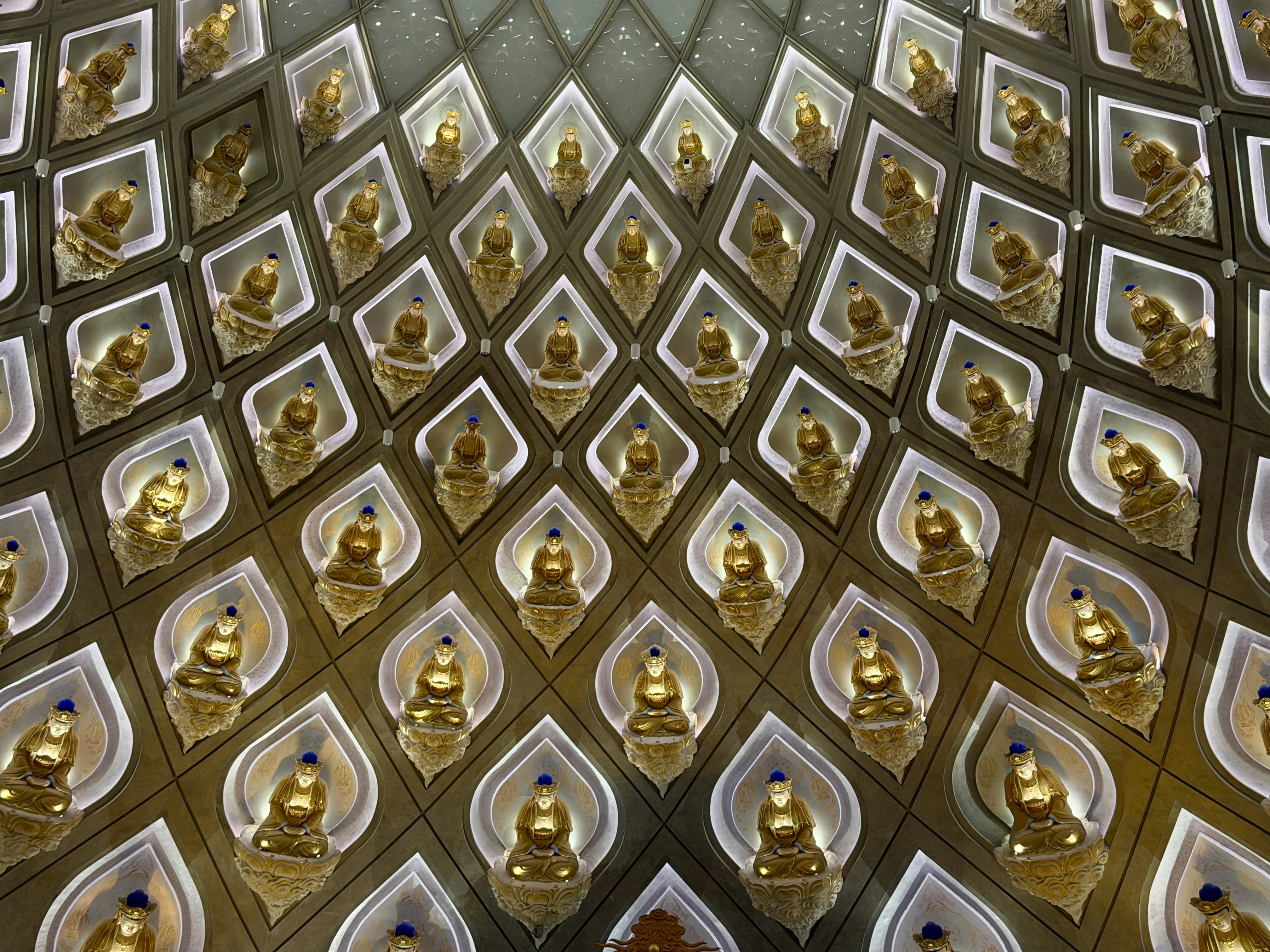 Infinite Golden Buddhas: a tiled ceiling of repeating meditative figures