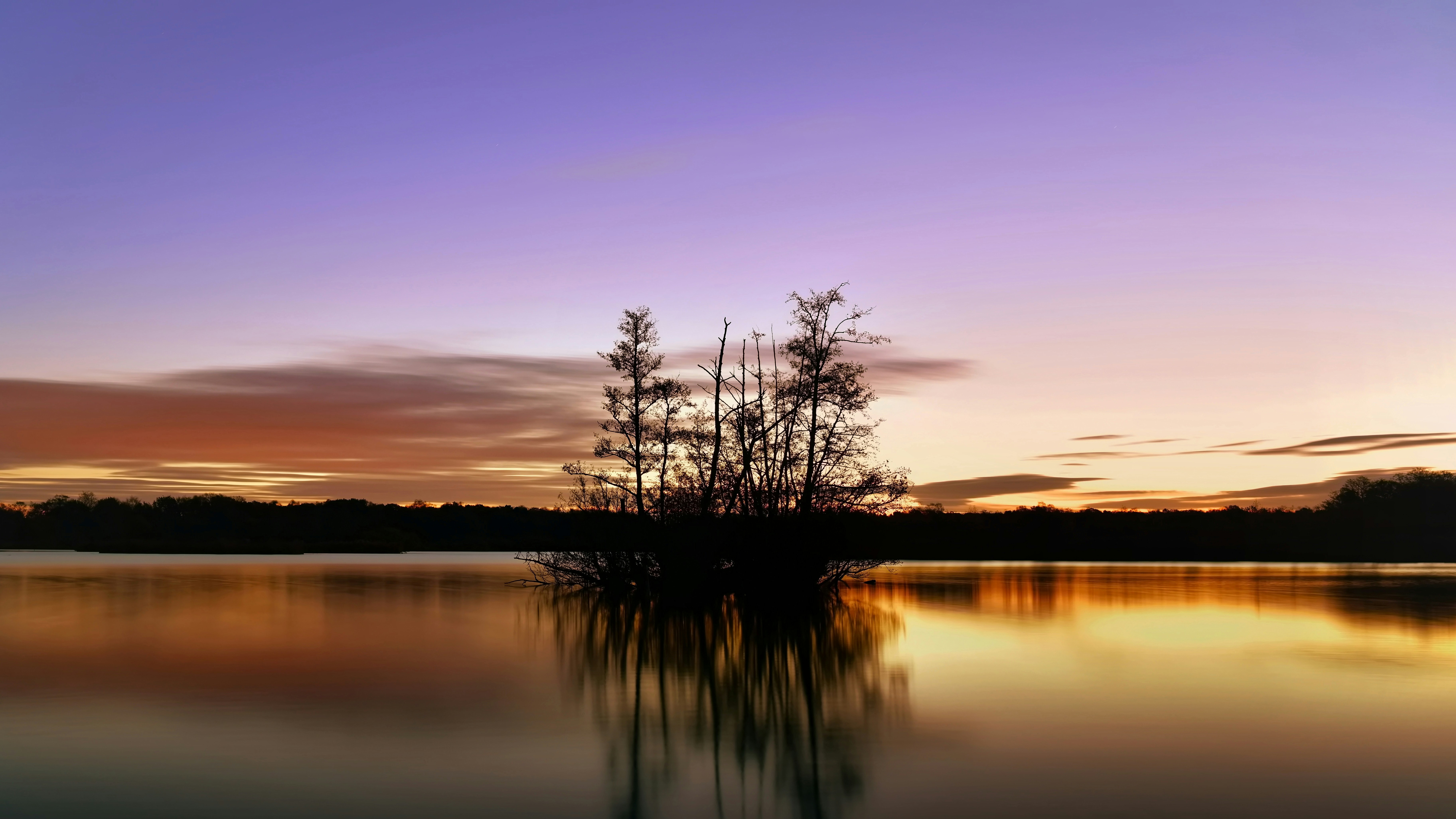 Silhouette at Dusk: Island of Reeds on a Glassy Lake