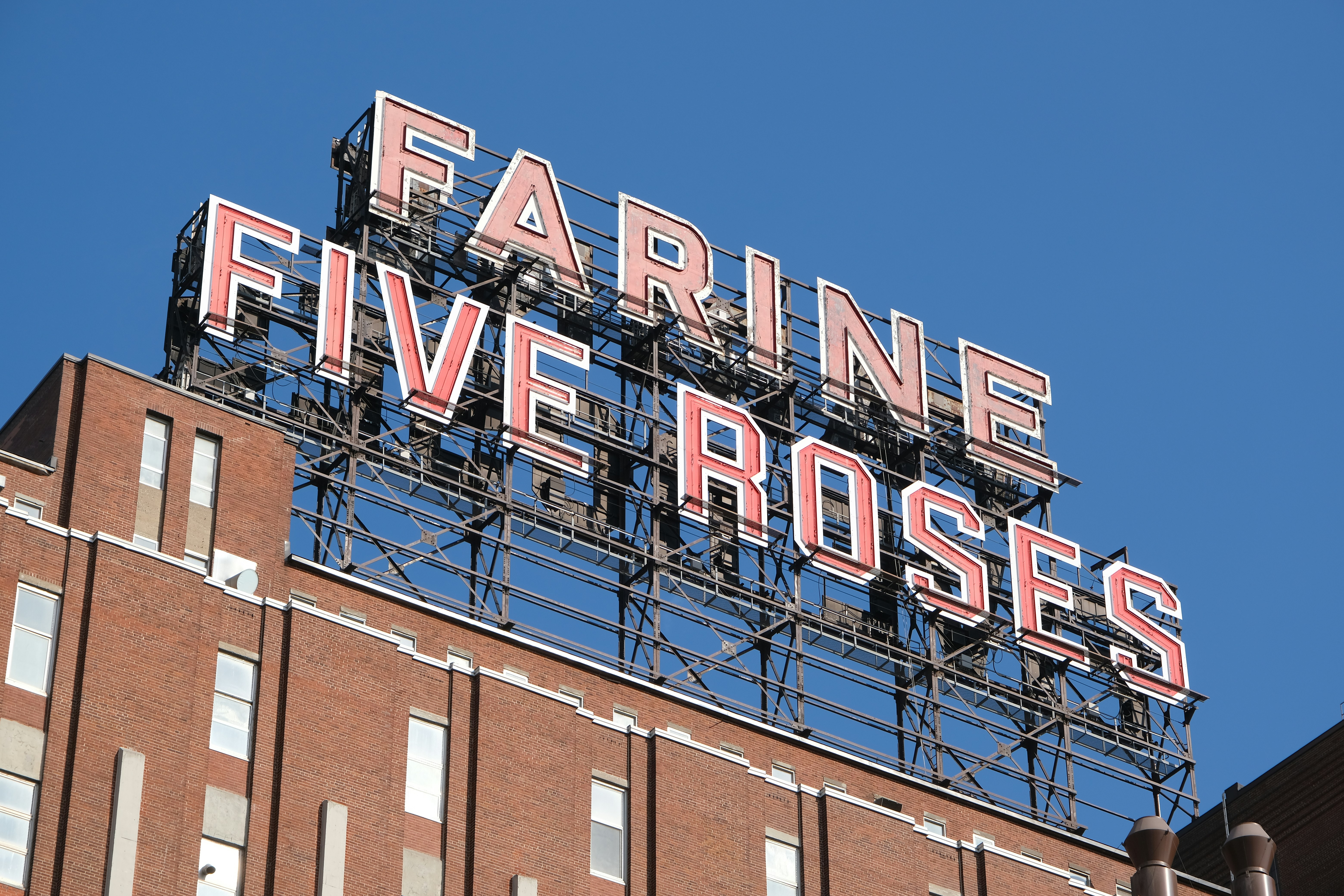 Neon Sign Over the Brick Facade: Farine Five Roses Towers in the Sky