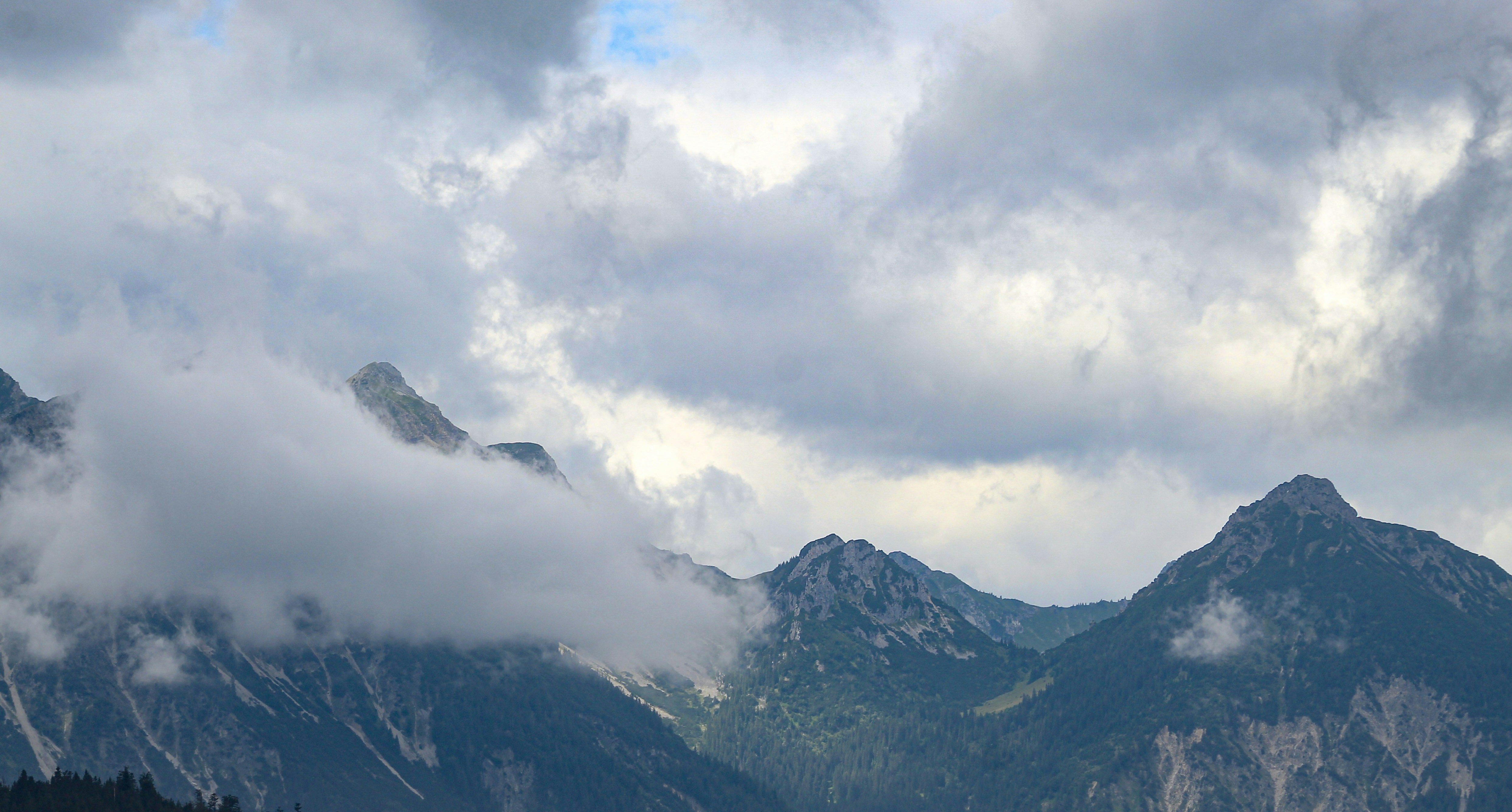 Mist-Trimmed Peaks: A Cloud-Worn Ridge Beneath Quiet Skies