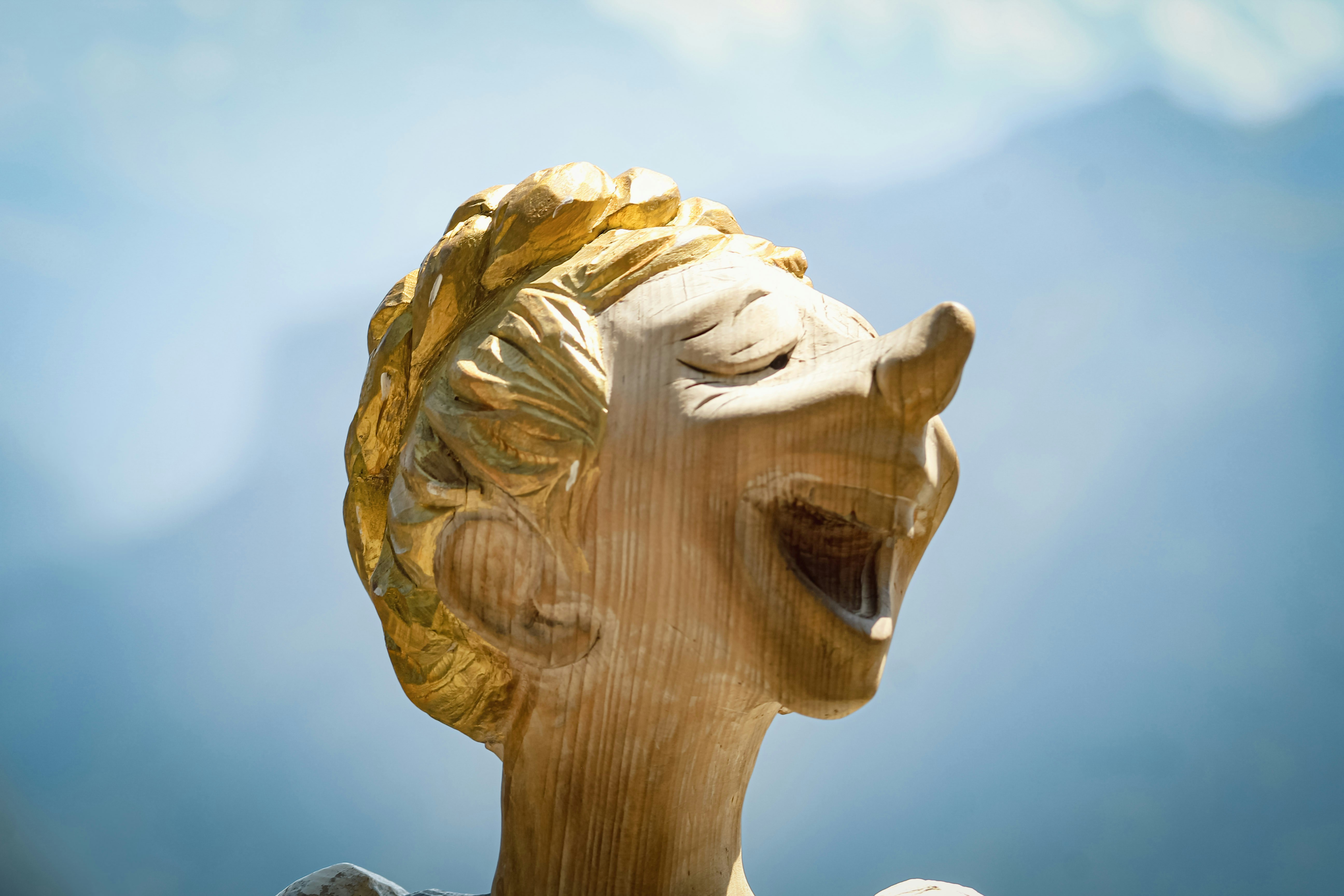 Golden Laugh: a carved head tilts toward the sky