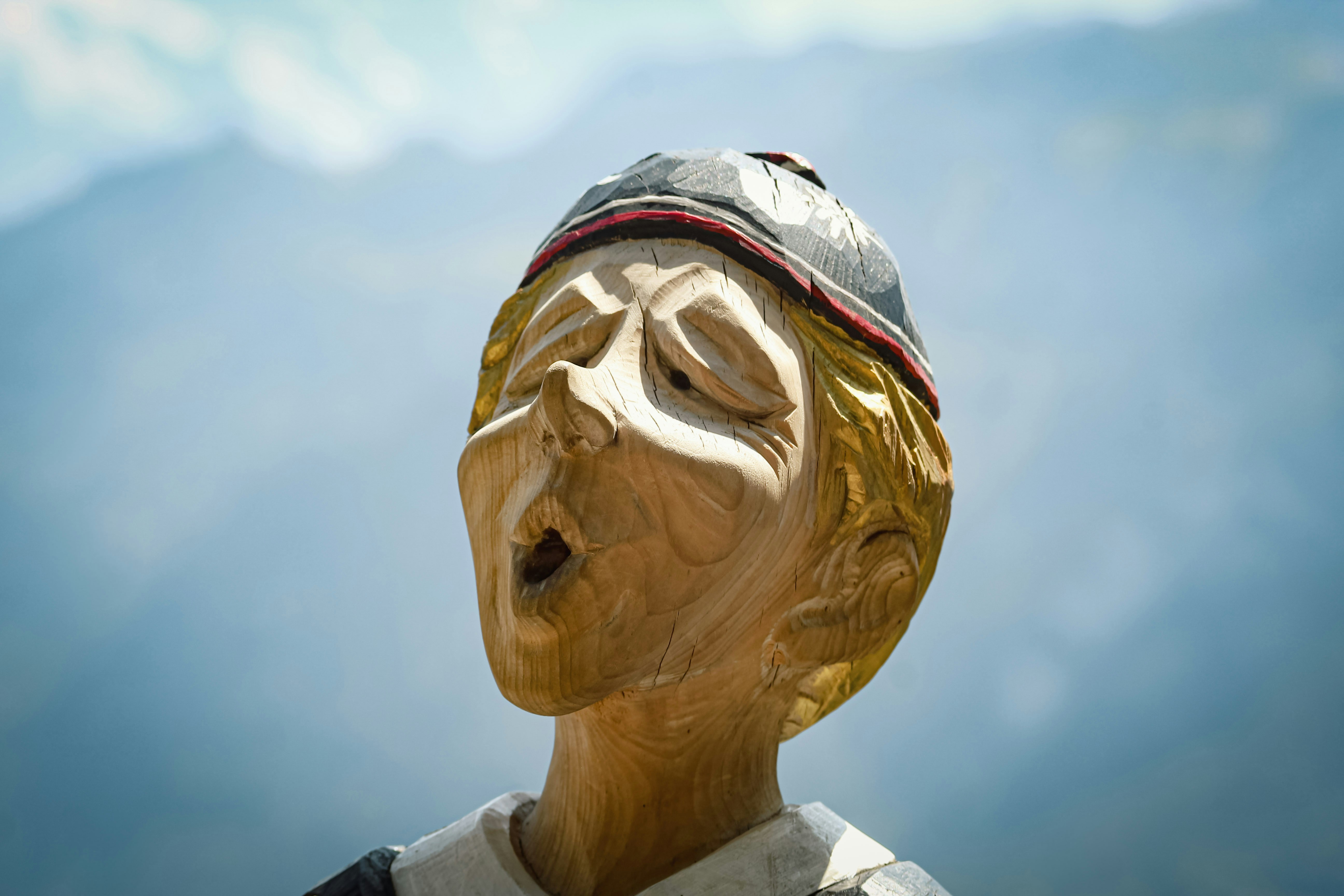 Carved Alpine Portrait: A Wooden Figure Reaching Toward the Sky