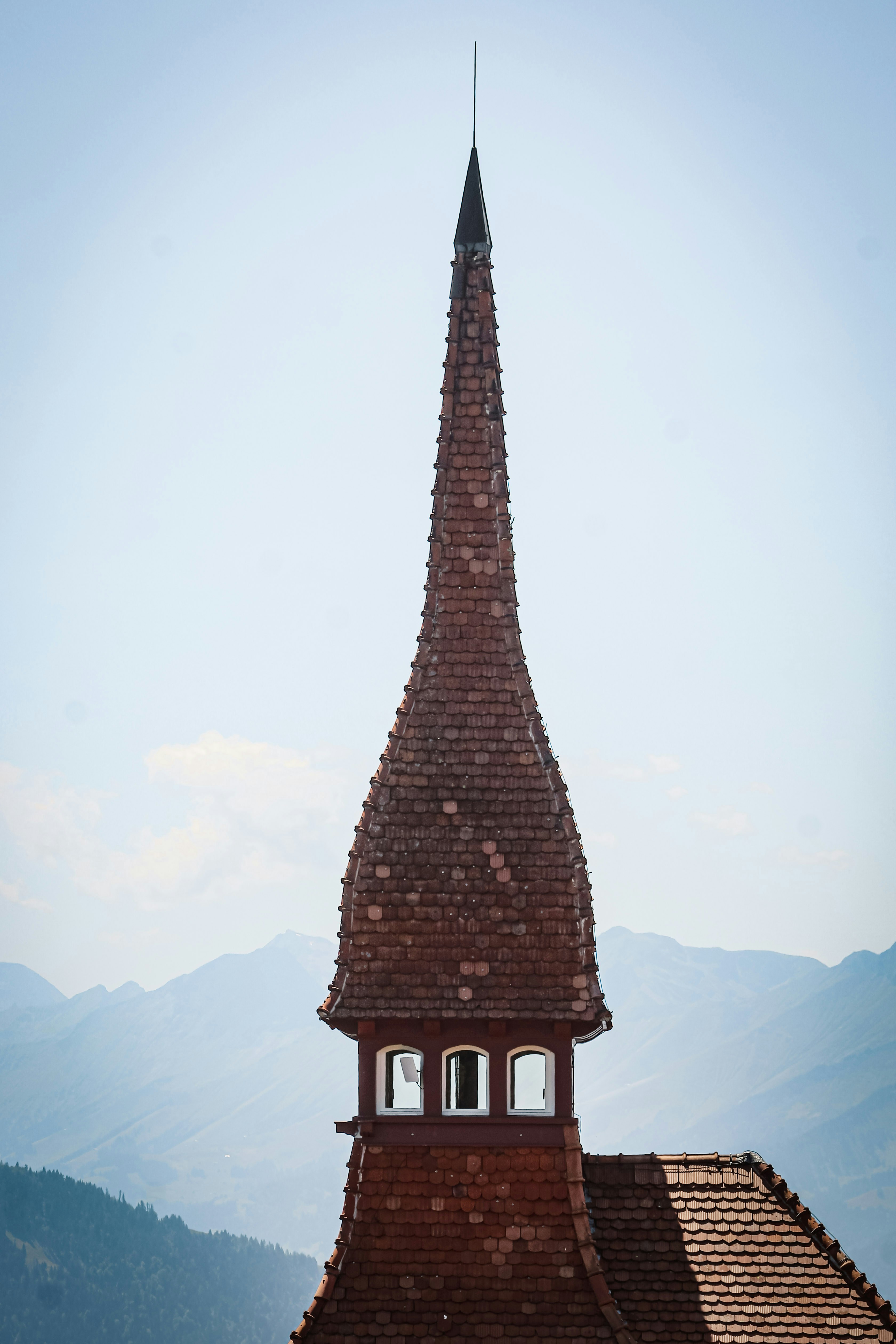 Wooden Spire Reaches for the Sky Against Alpine Blues