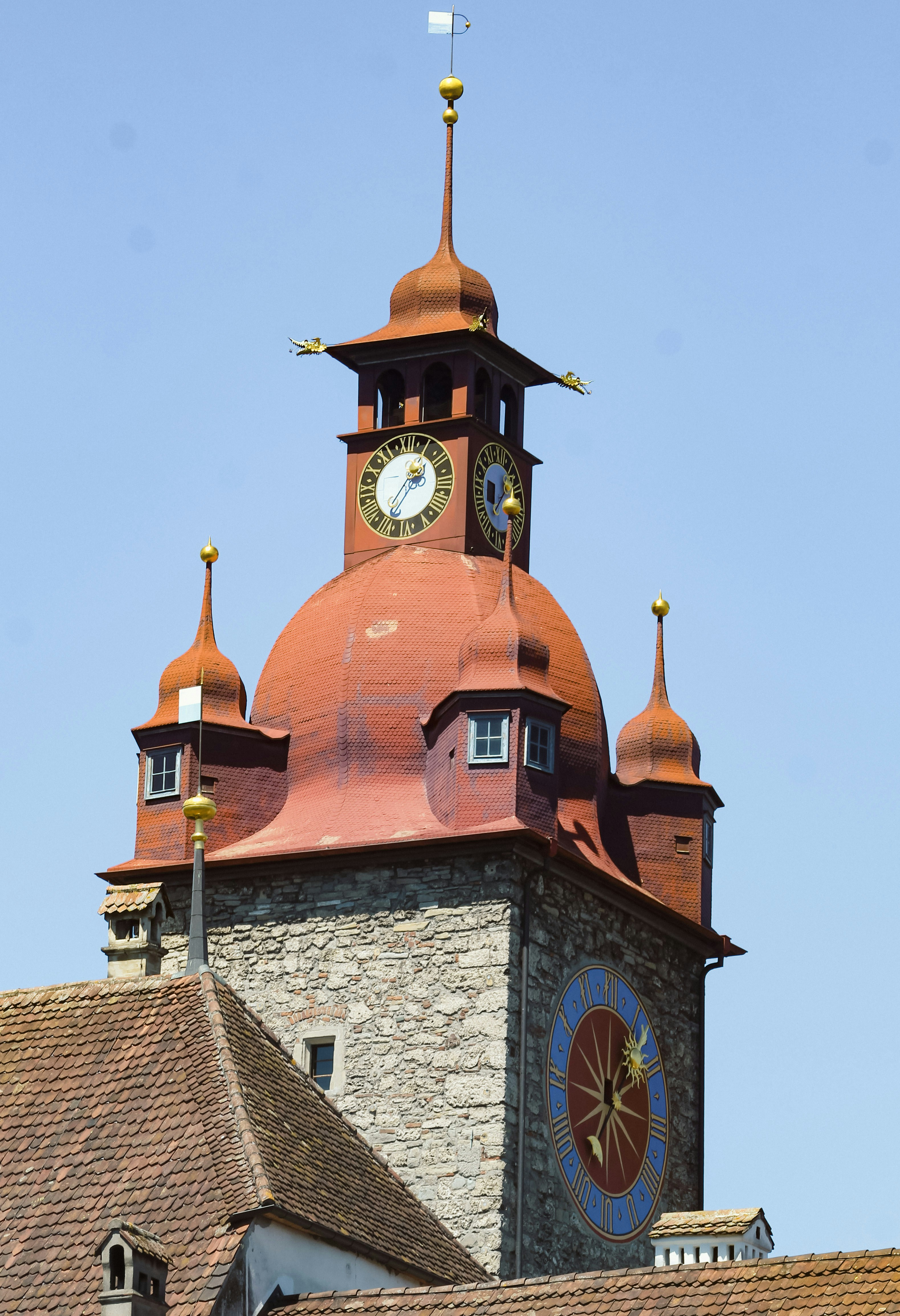 Clocktower with Red Domes Piercing a Clear Blue Sky
