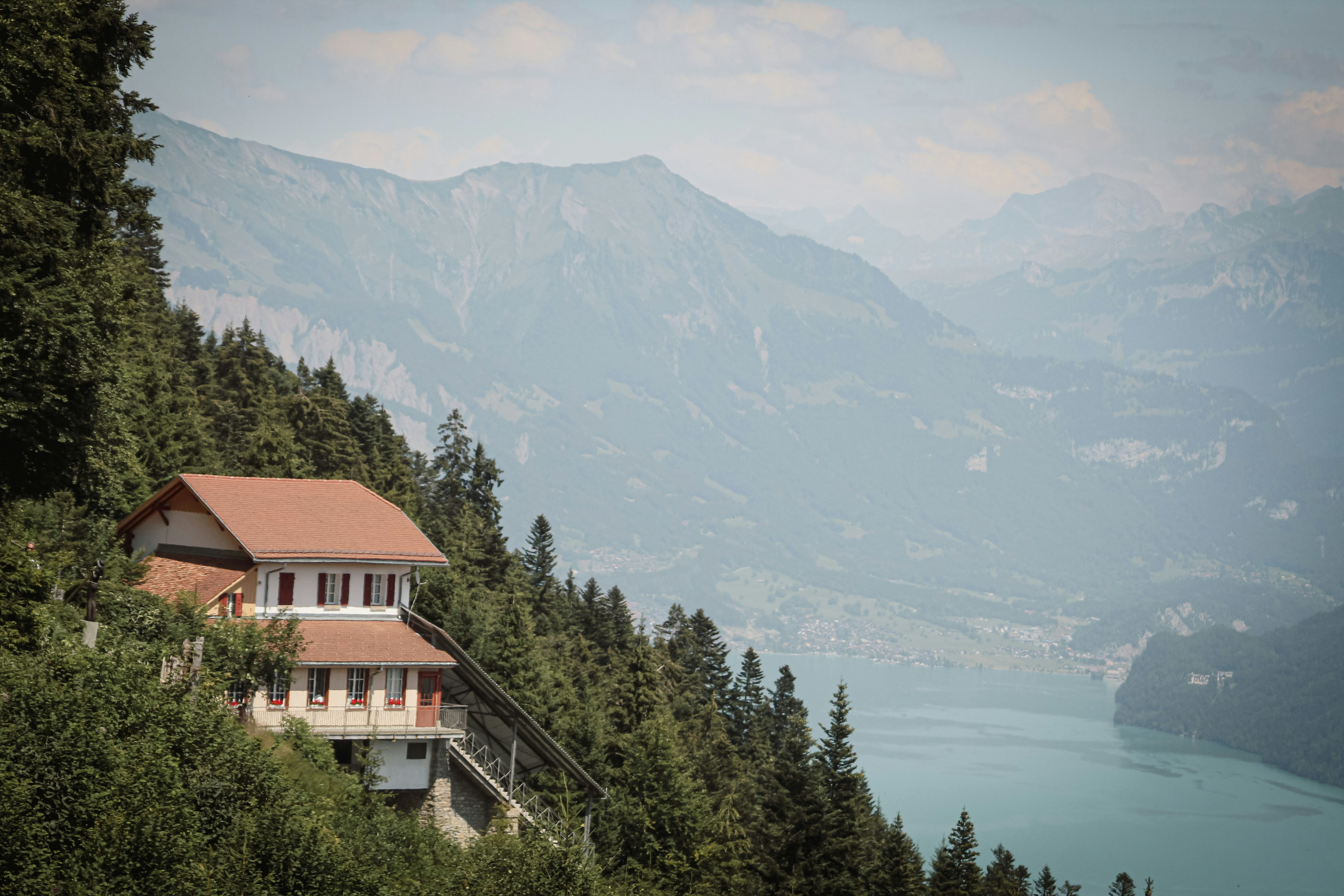 Terraced Chalet Clinging to the Alpine Forest Overlooking a Turquoise Fjord