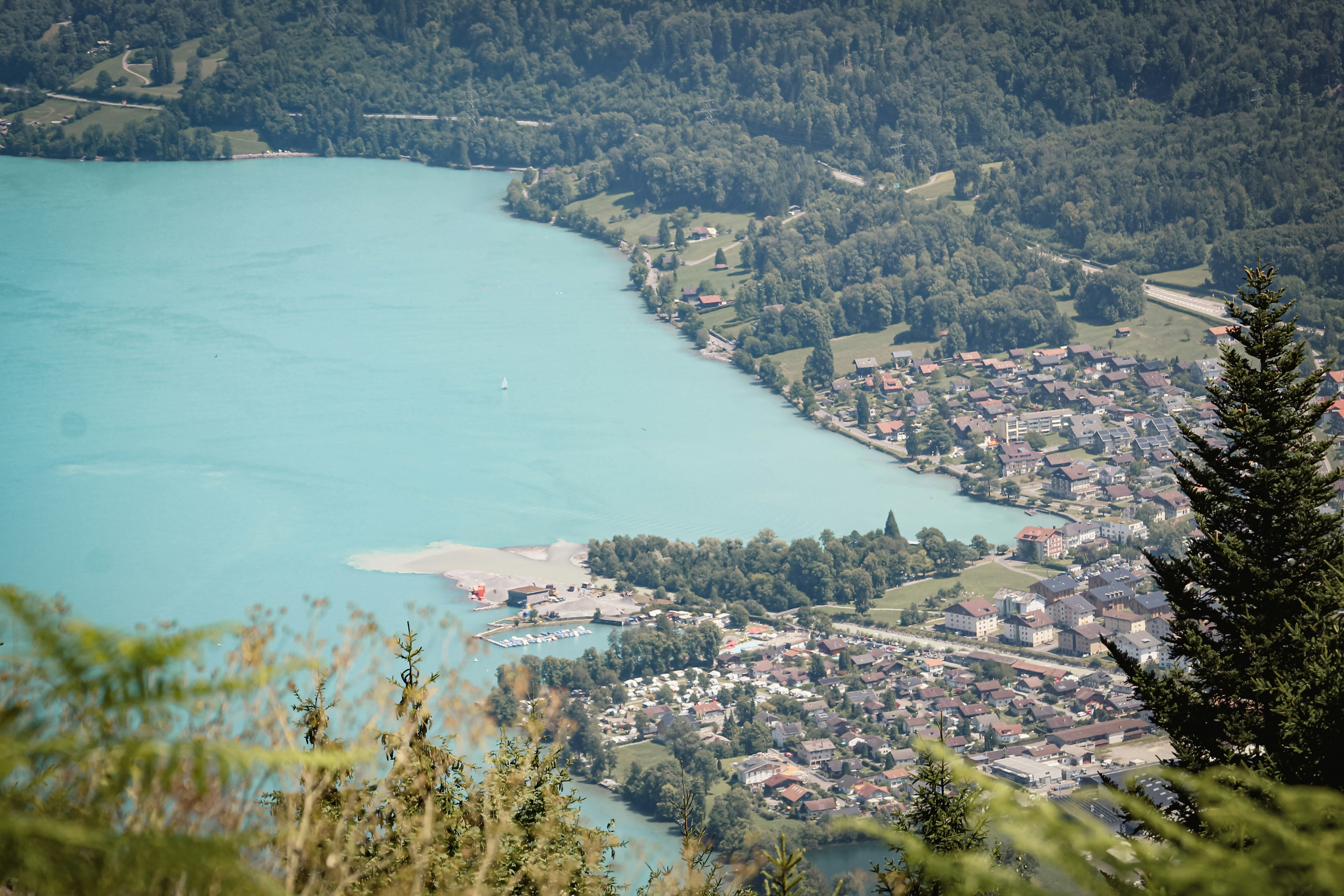 Skyline of a turquoise lake curving along a hillside village