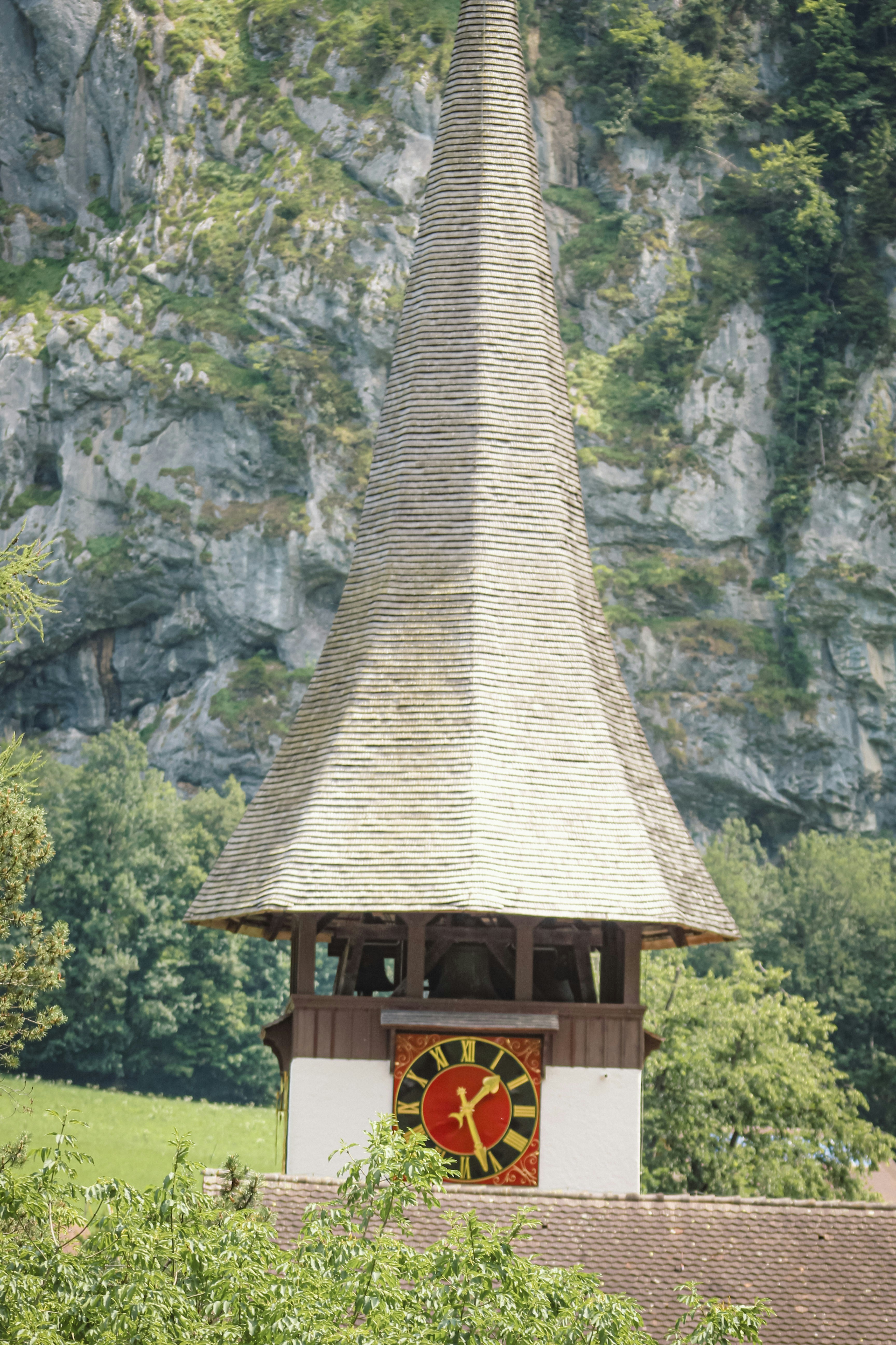 Conical roof tower crowned with a weathered shingle spire