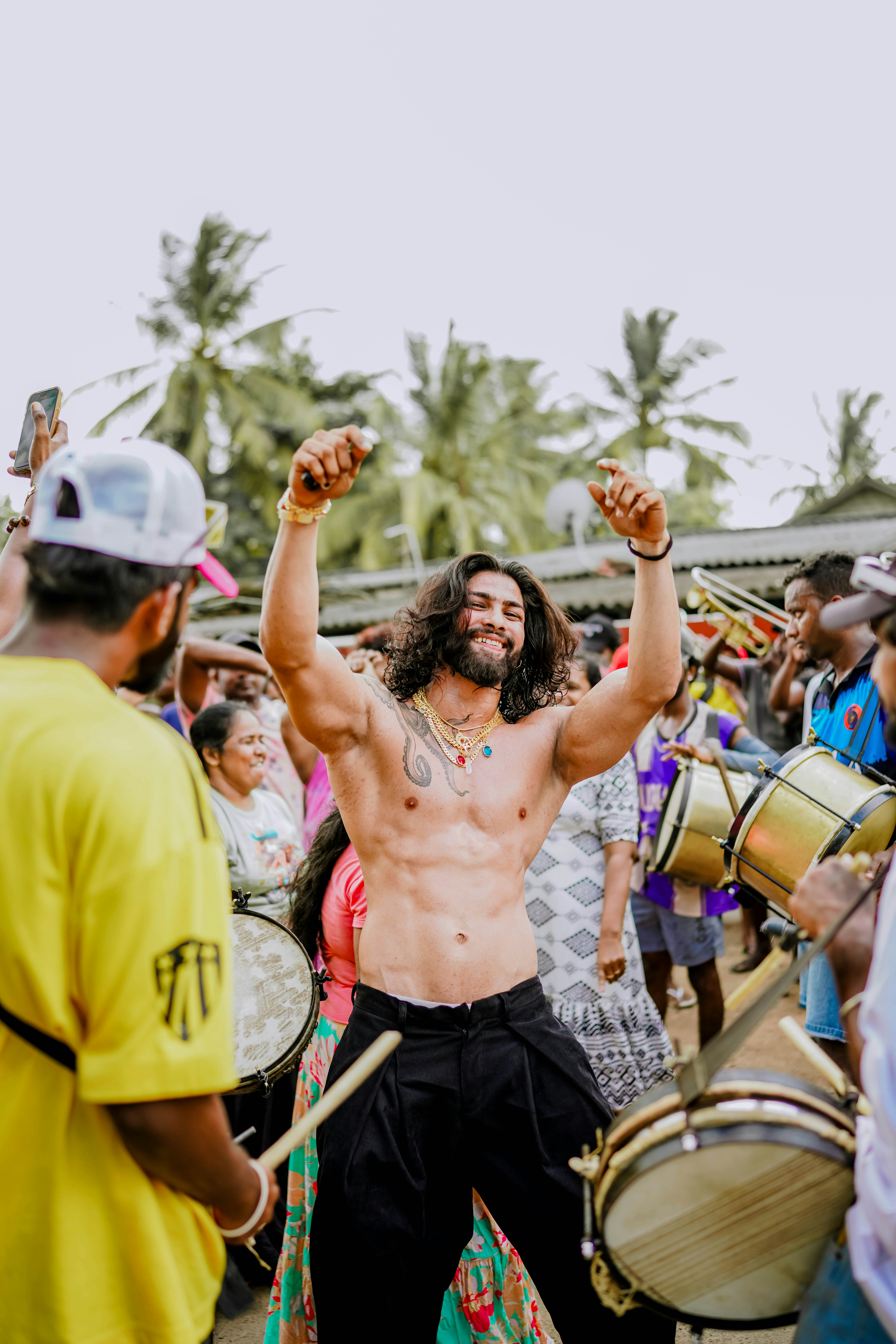 Ritual of Rhythm: The Shirtless Leader at the Drum Circle