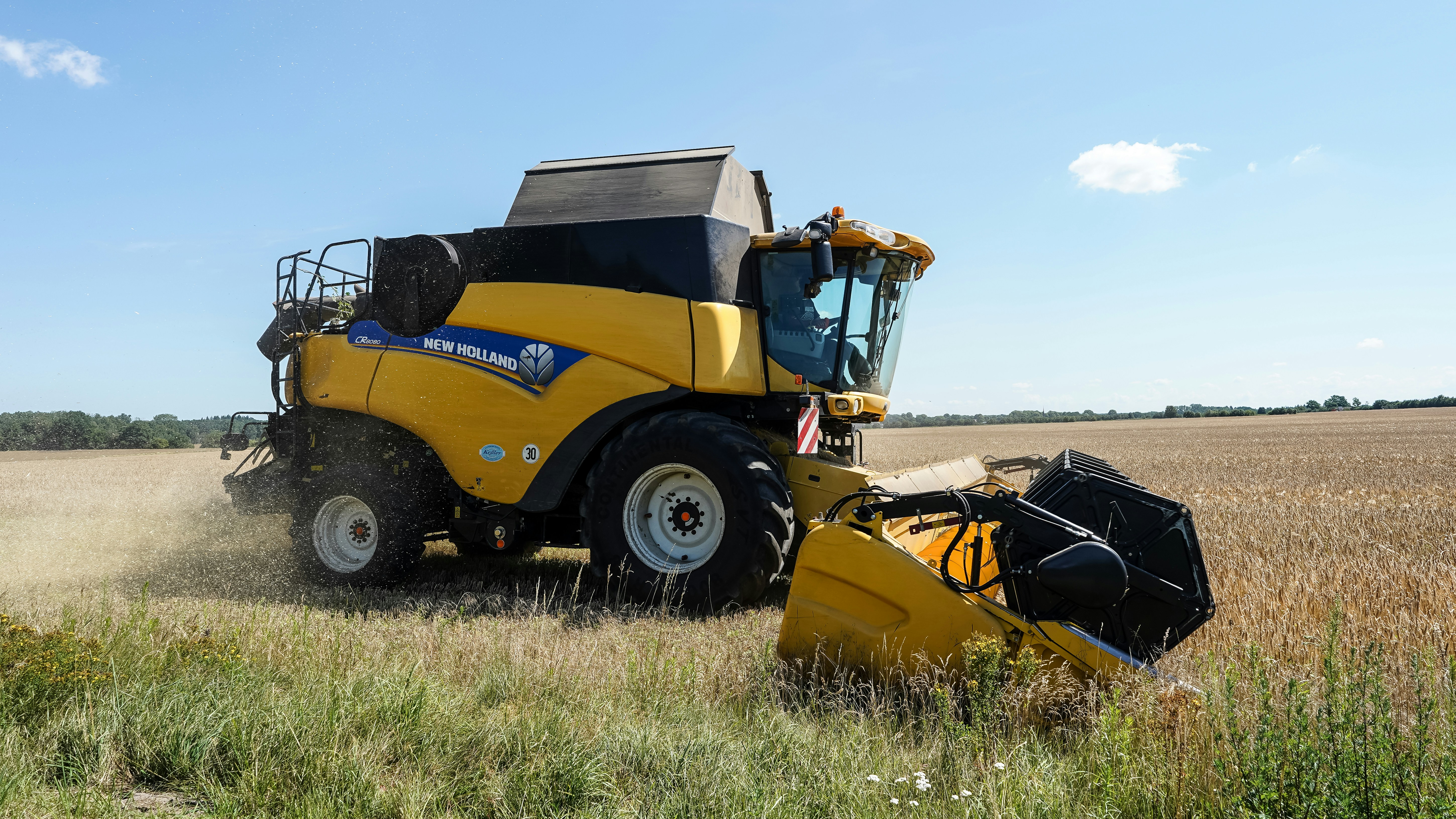 Yellow Harvester in a Golden Harvest Field