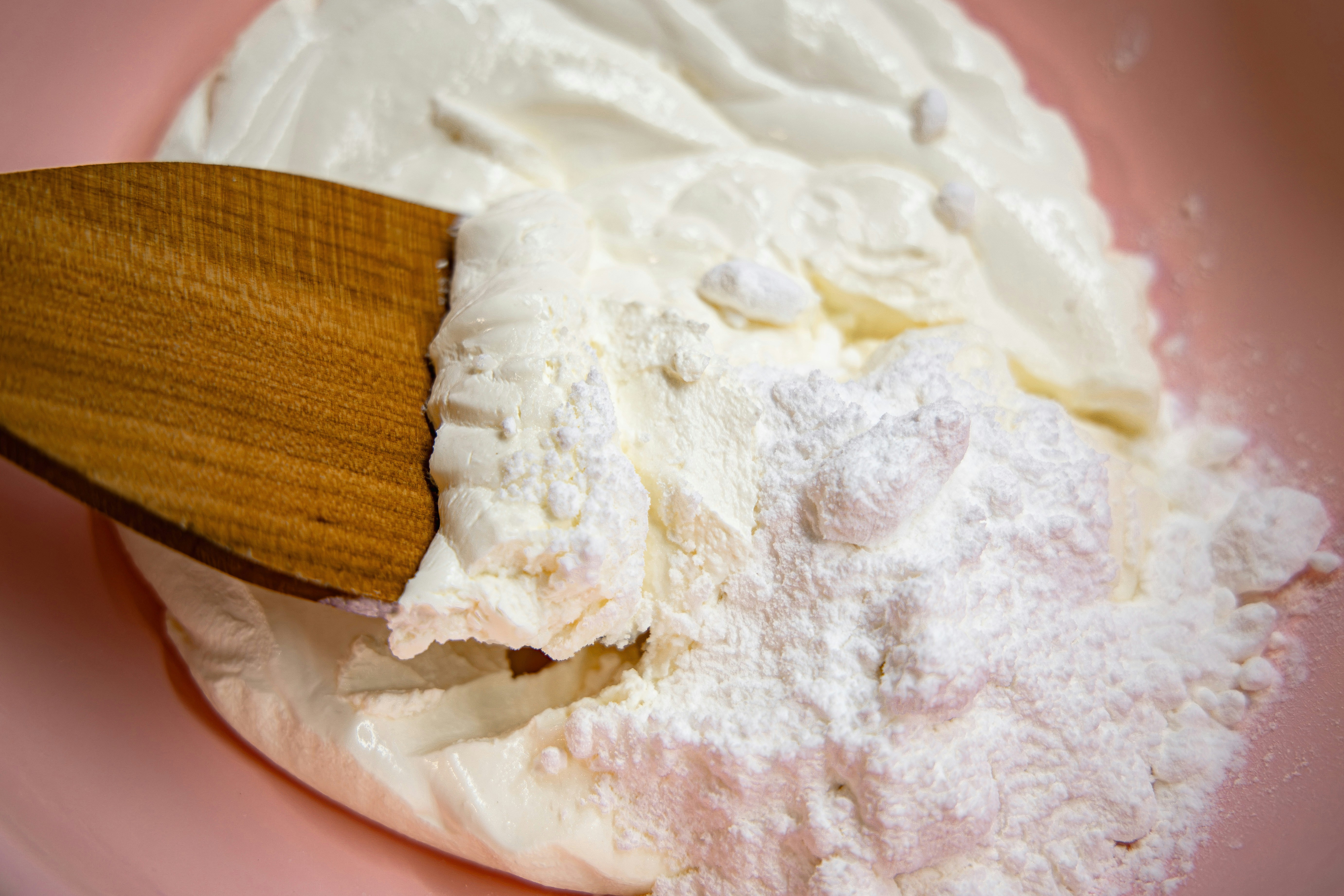 Creamy Confections: A Wooden Spatula Lifts Soft Whipped Peaks