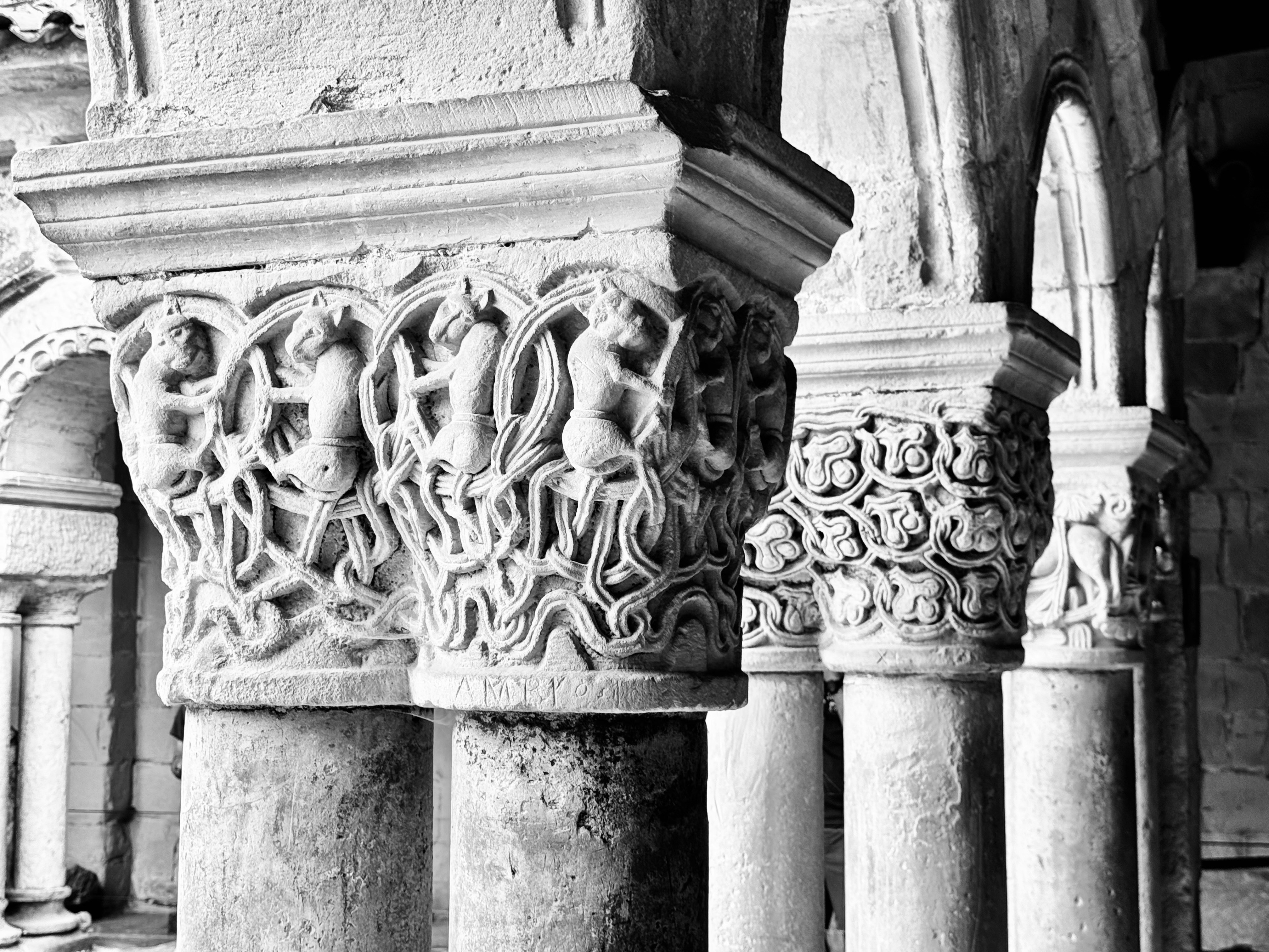 Carved Columns in a Monastic Arcade: A Study in Stone and Shadow