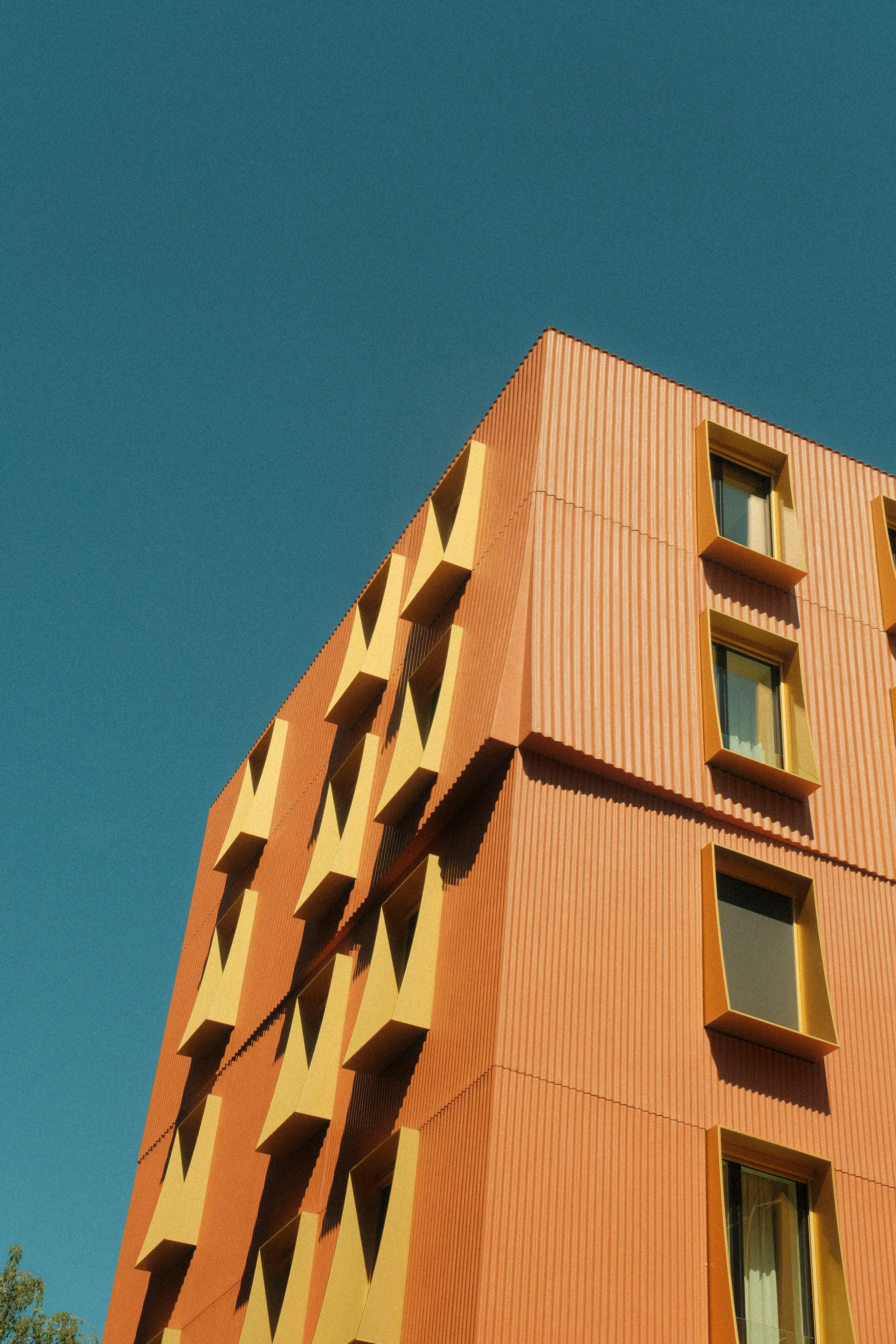 Corner of the Sunlit Brick: A Bold Facade Reaching Toward the Sky