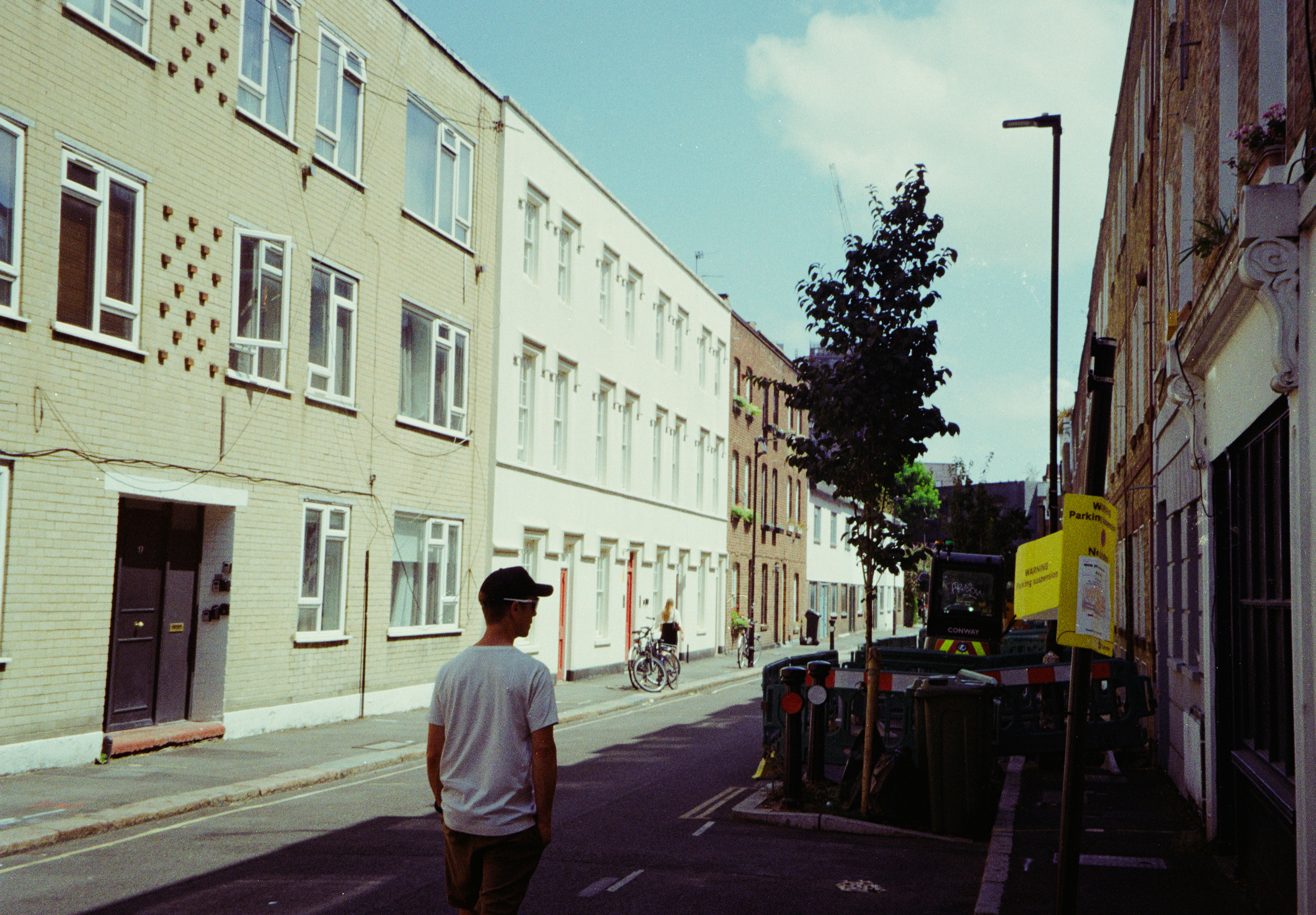 Halfway Down the Street: A Stranger Walks Past a Quiet Alley