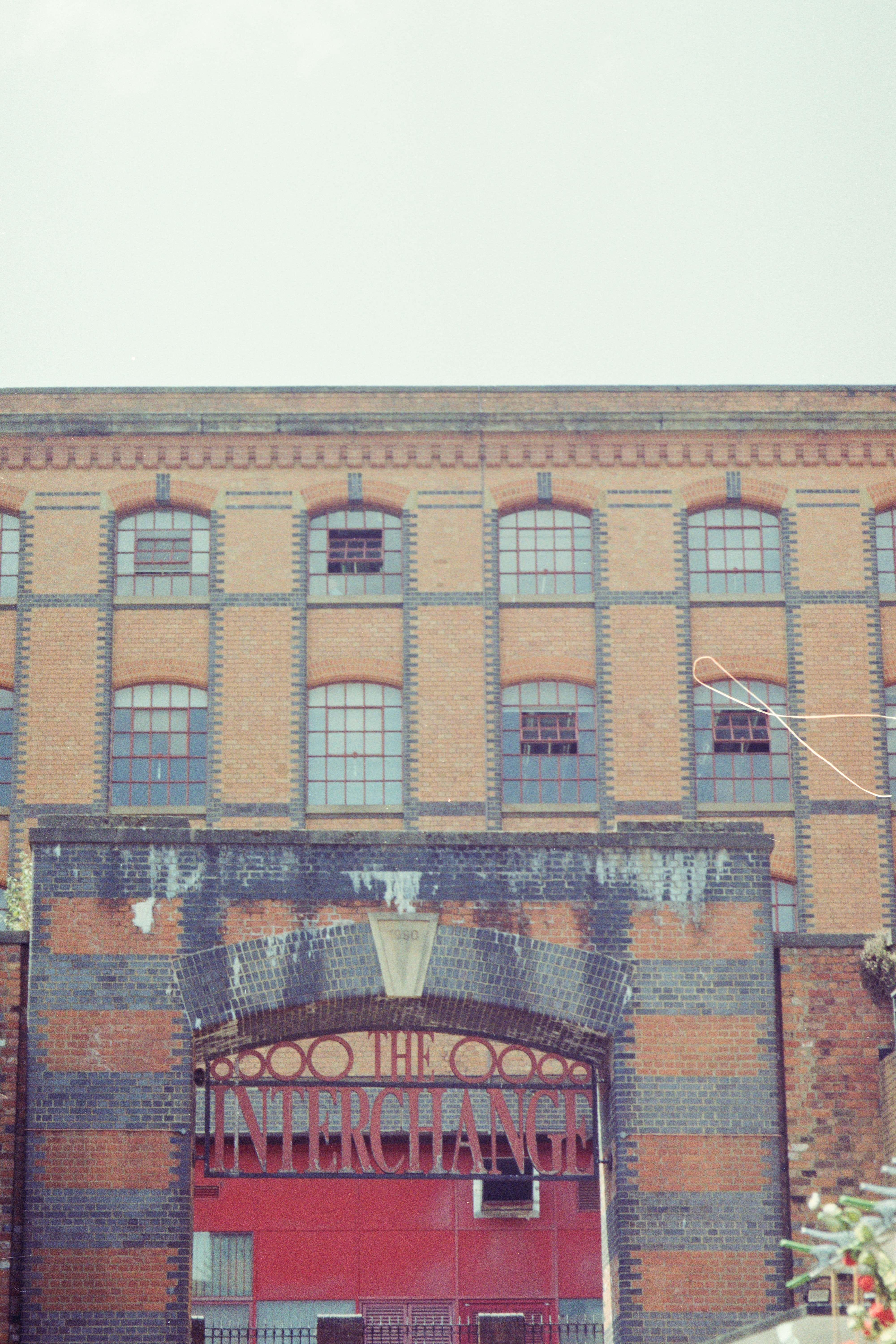 Brick Facade and Red Entrance of The Exchange Sign