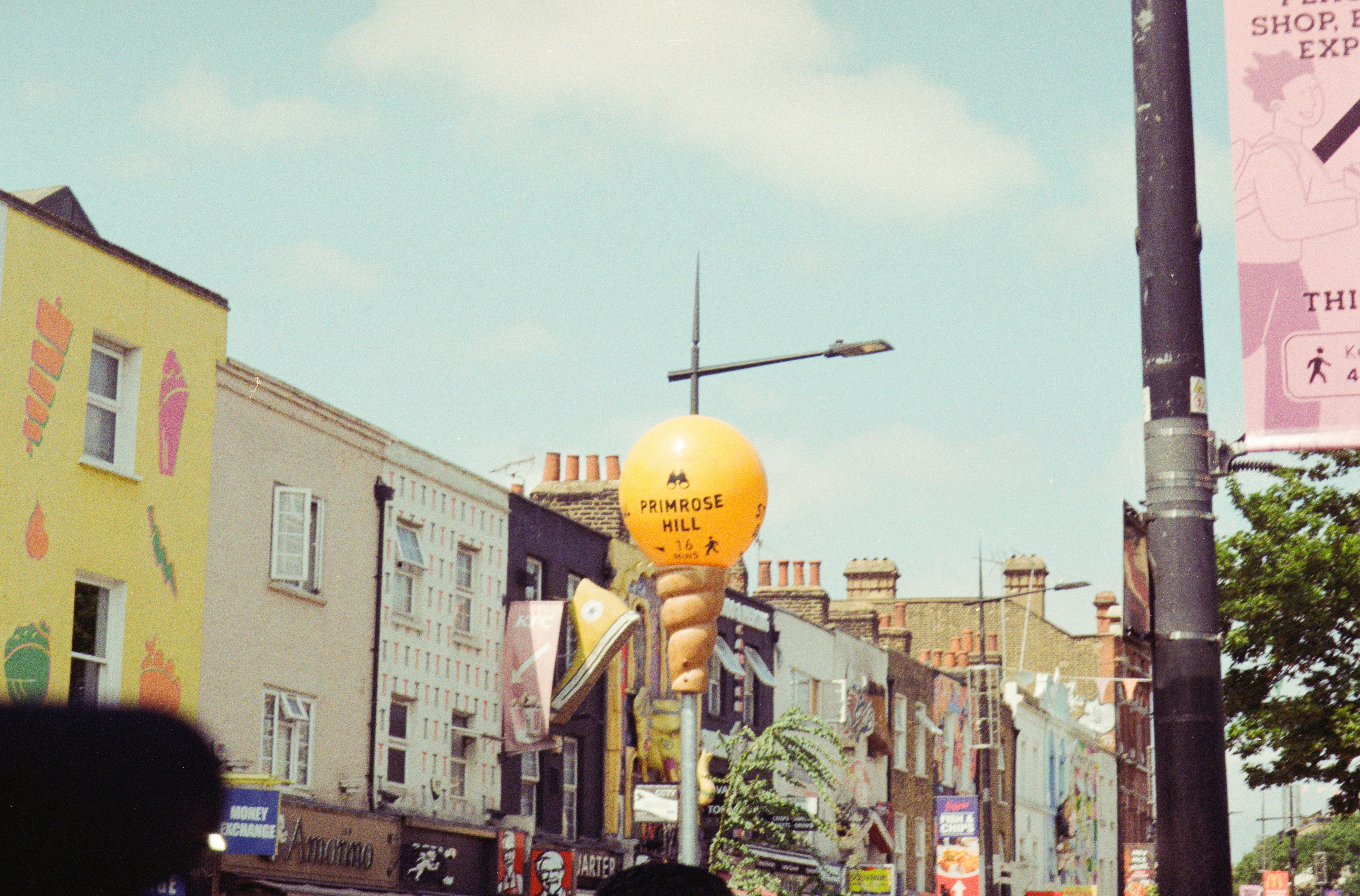 Golden Balloon Amid Colorful Street Canyon