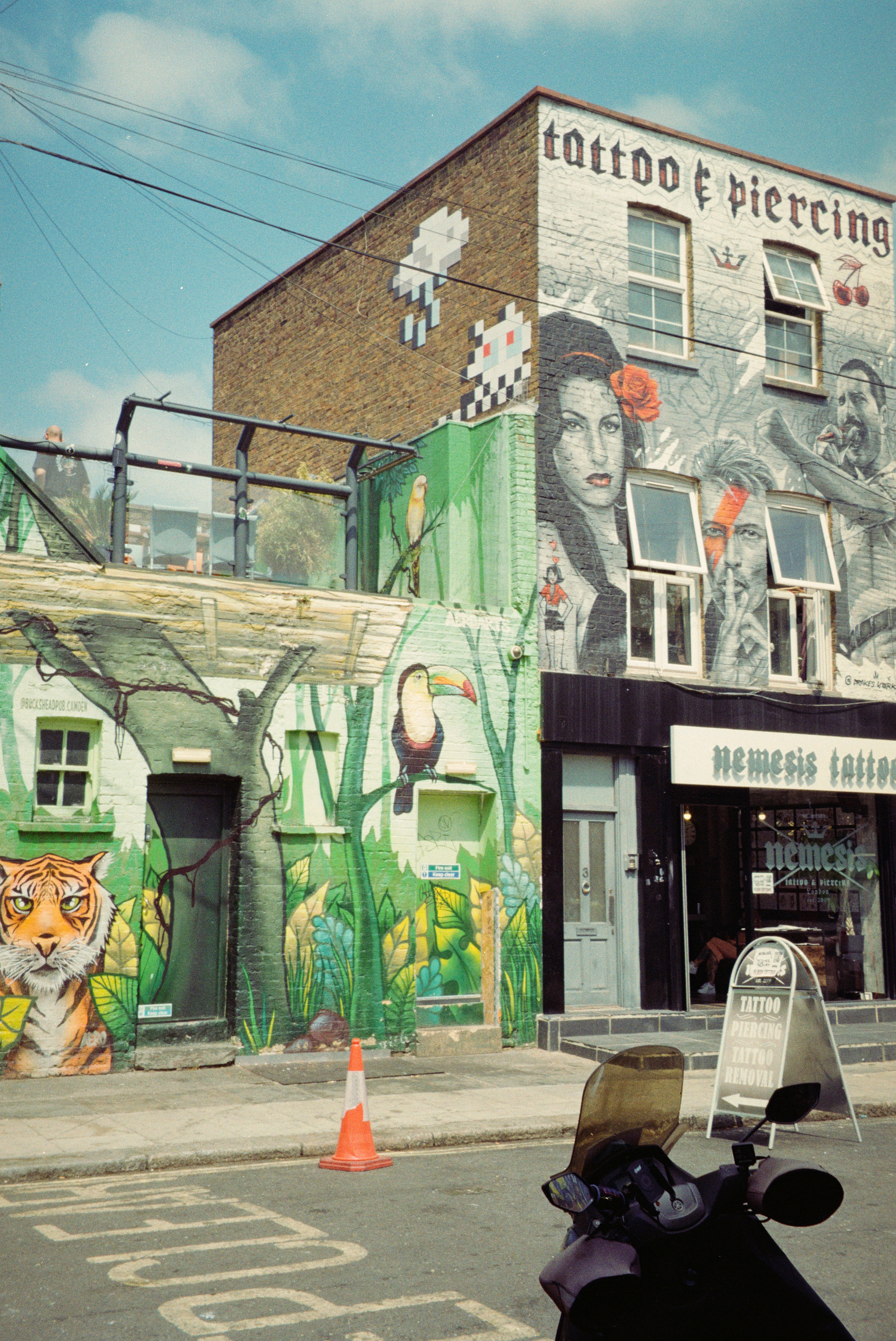 Vibrant Street Murals Meet Urban Quiet: A Motorcycle at the Edge of Color