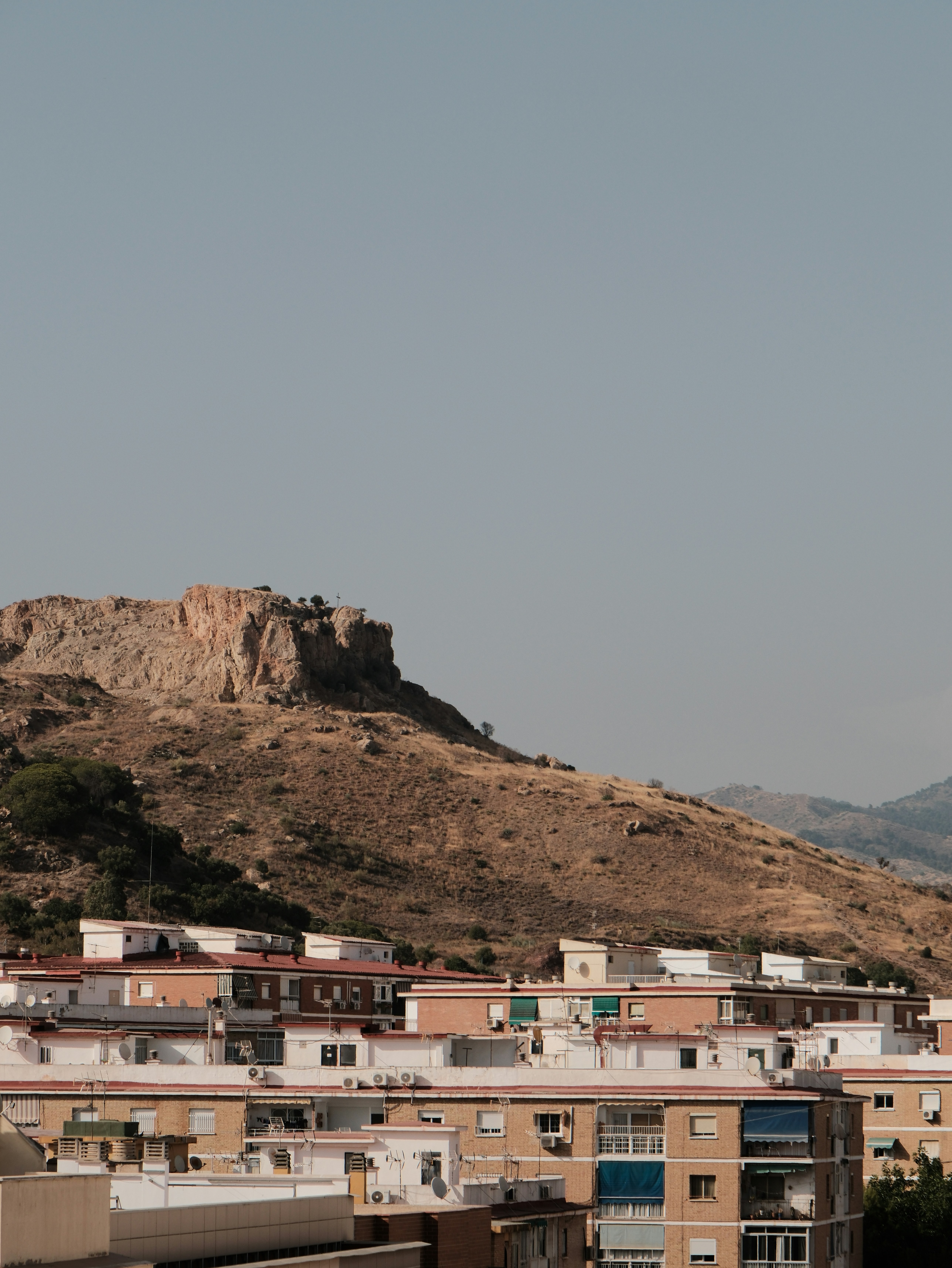 Hilltop Ruin Overlooking a Quiet Residential Valley