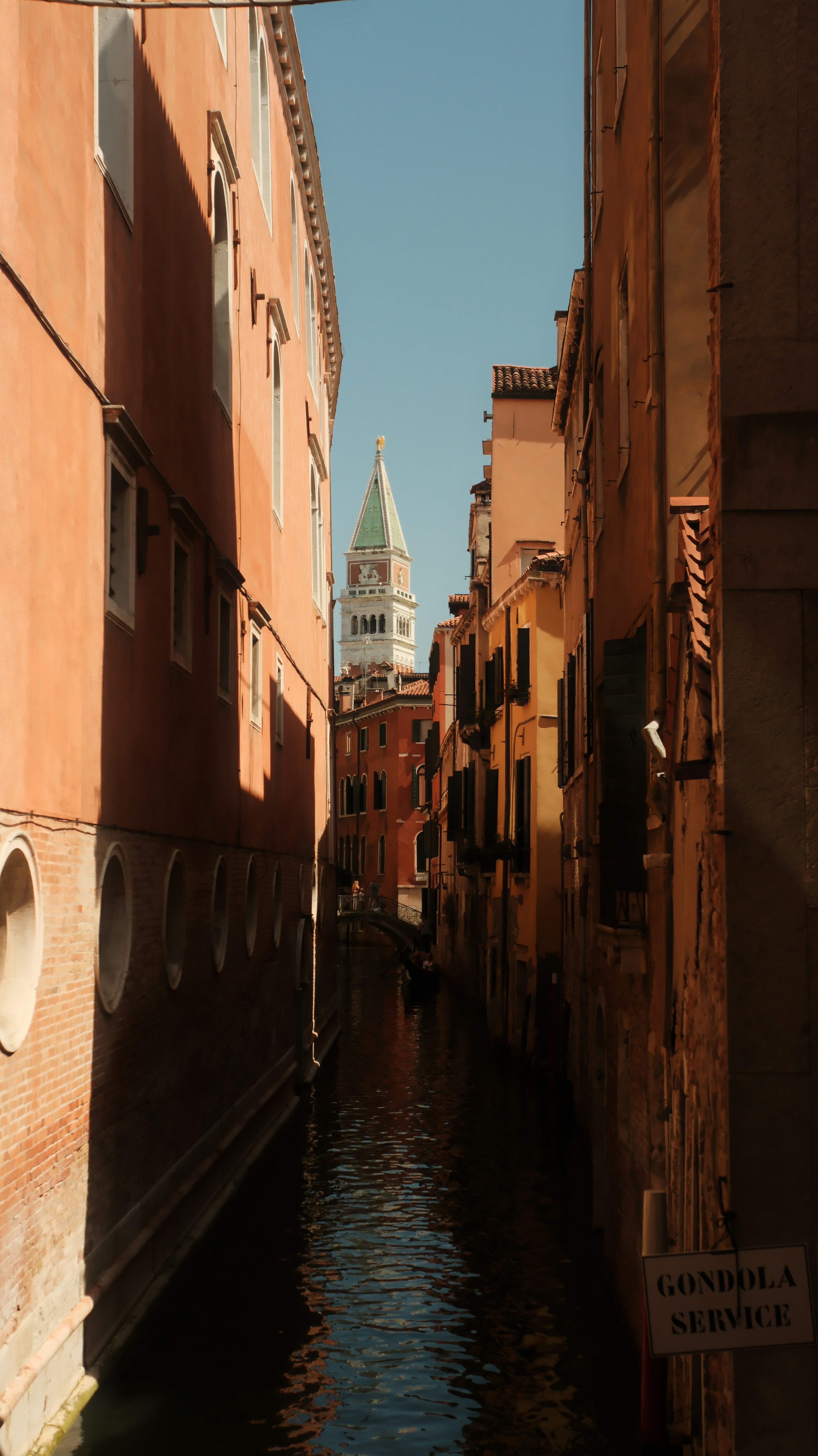 Channel to the Campanile: a sunlit Venetian canal between warm facades