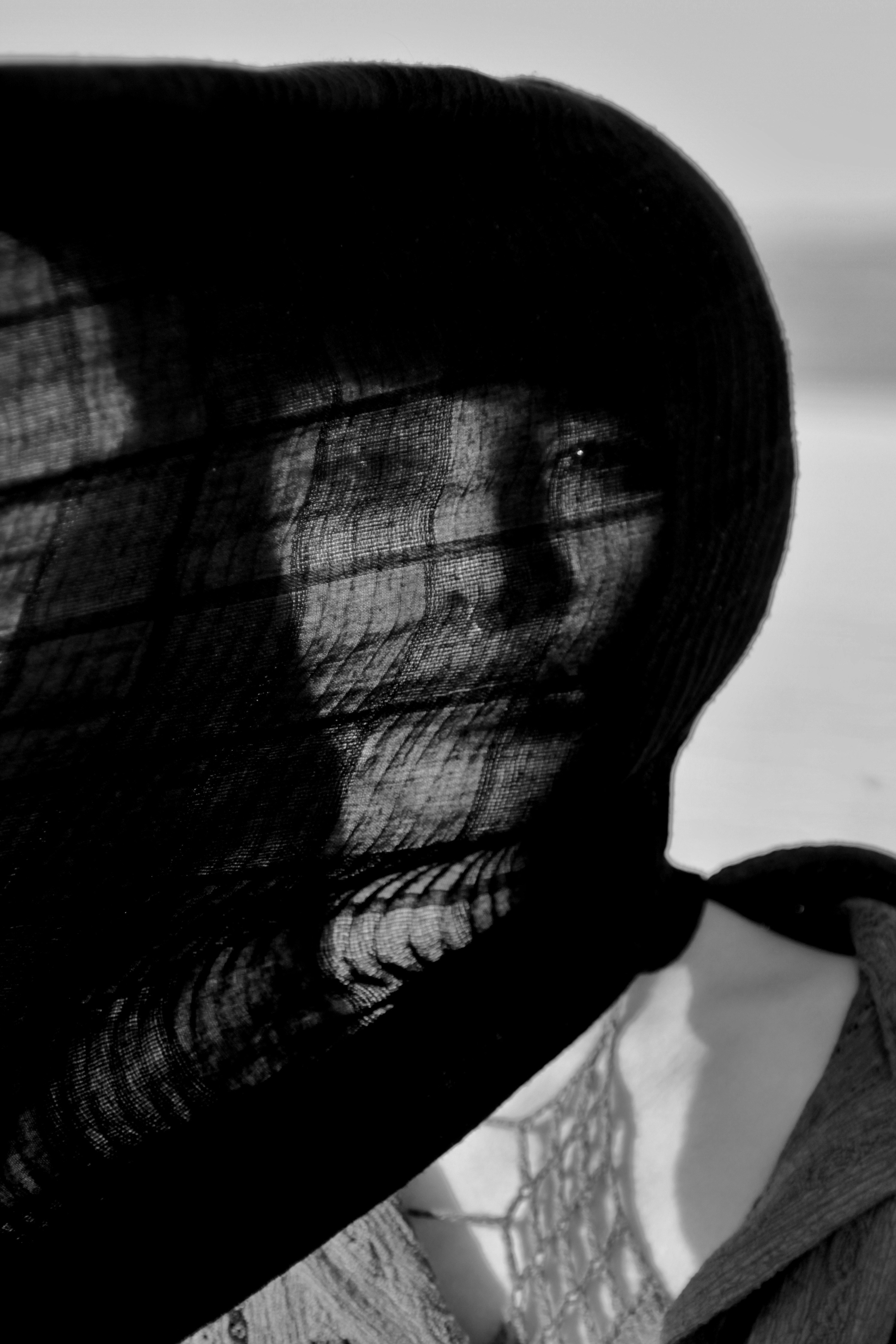 Veiled Gaze: A Hidden Portrait in Sand and Shadow