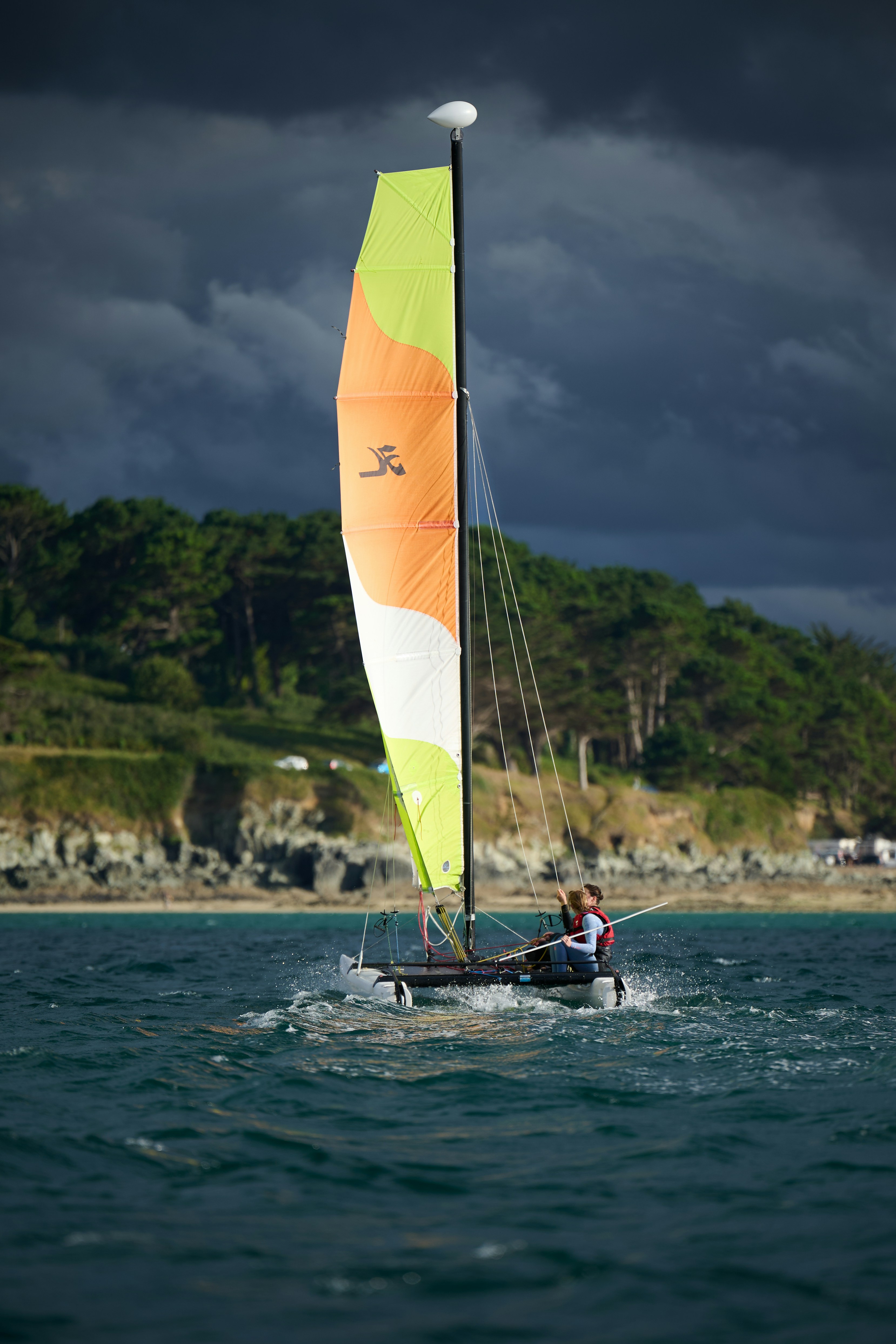 Windward Joy: A Sailboat Tackling choppy seas under a dramatic sky