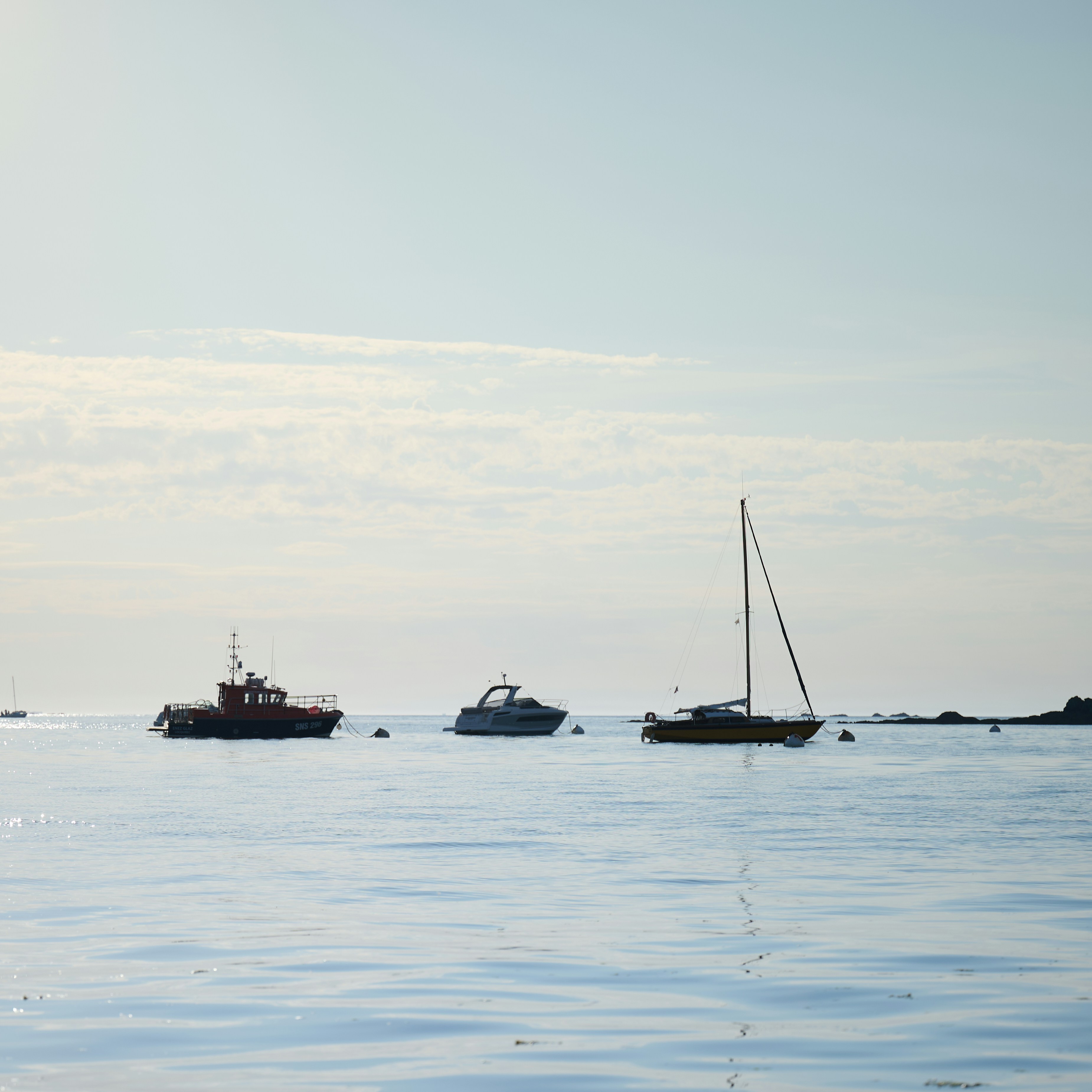 Harbor Silhouette at Dusk: Boats Riding a Glassy Horizon