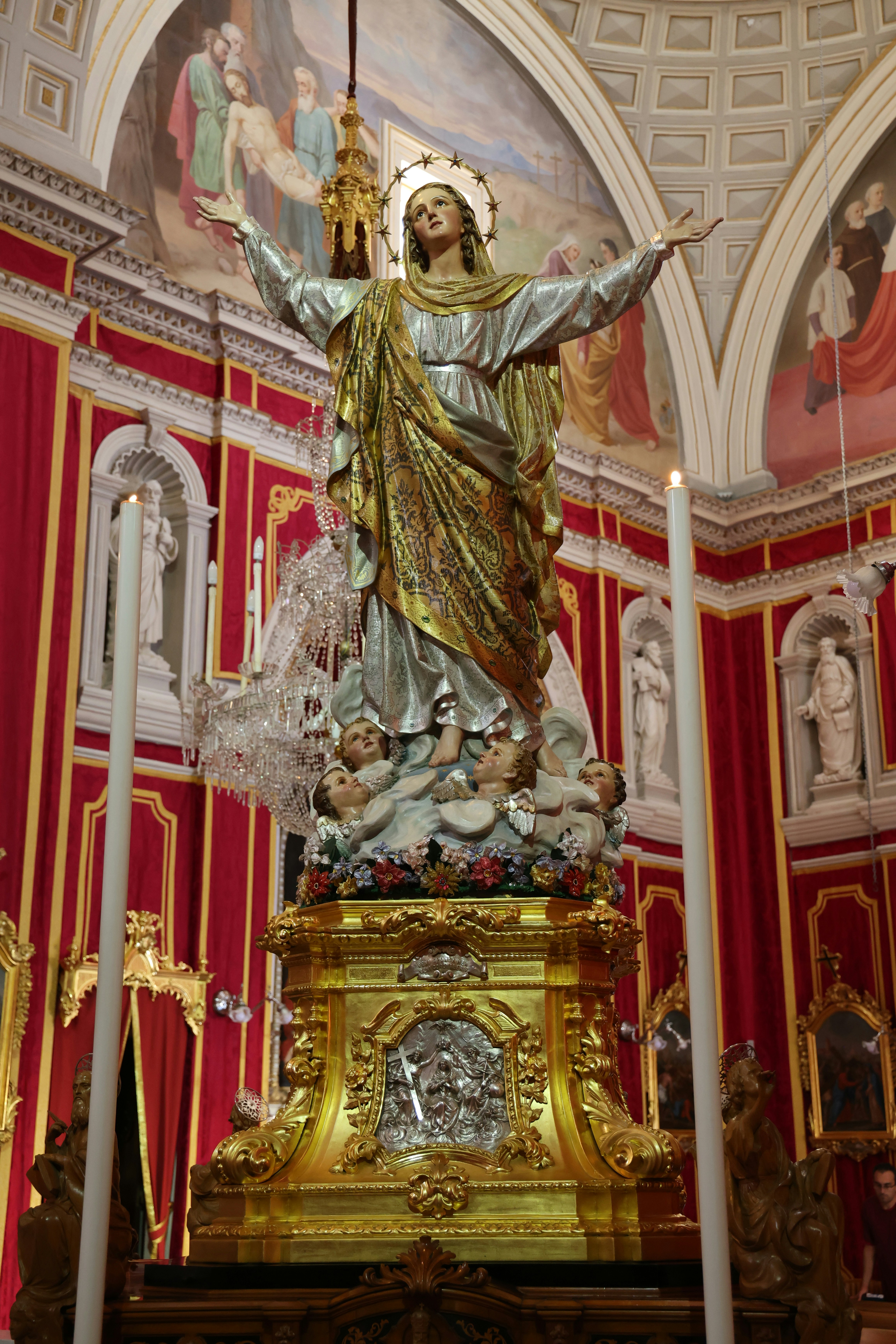 Statue of the Sacred Heart Above an Ornate Golden Altar in a Velvet-Red Cathedral
