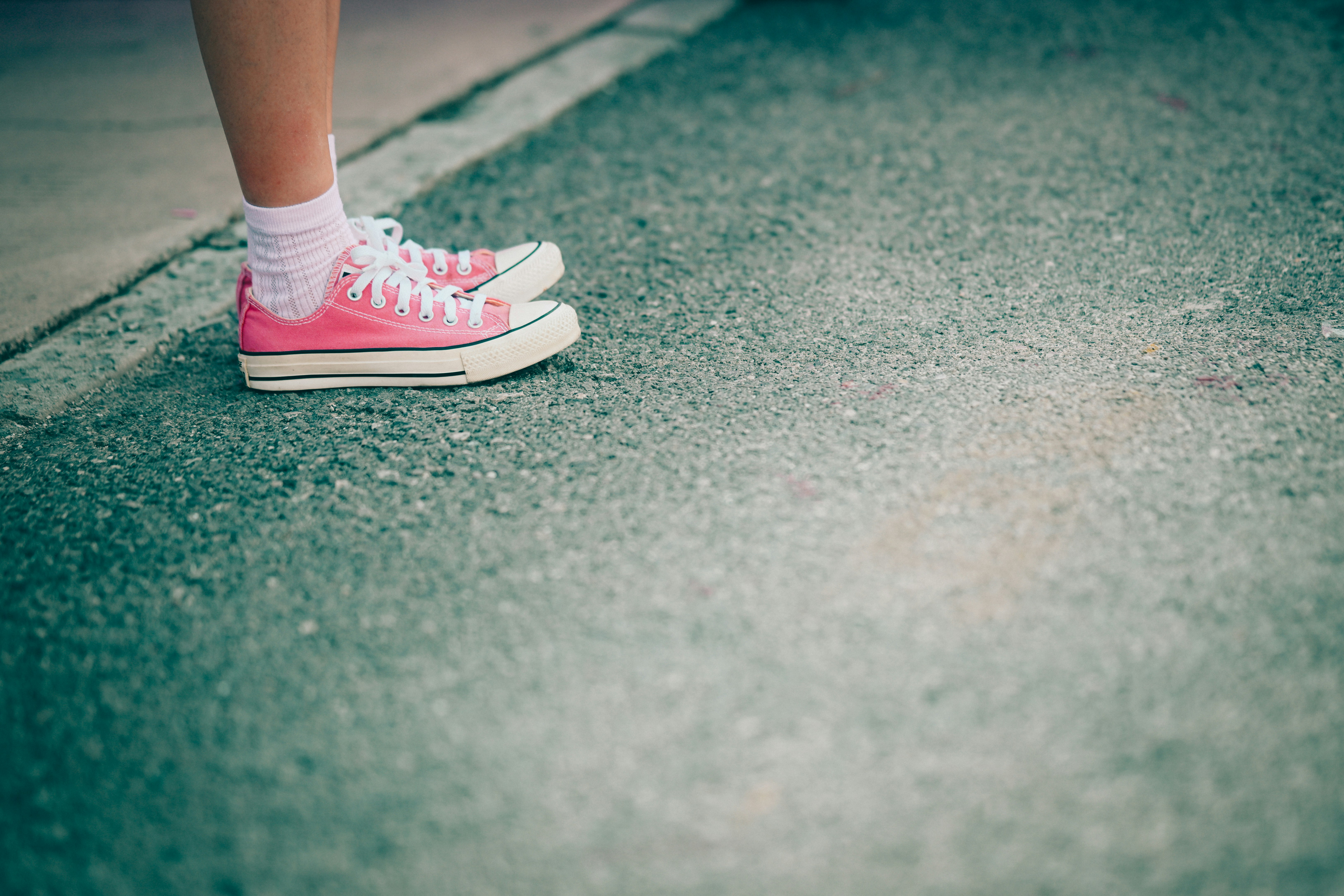 Pink Sneakers on the Edge of the Street