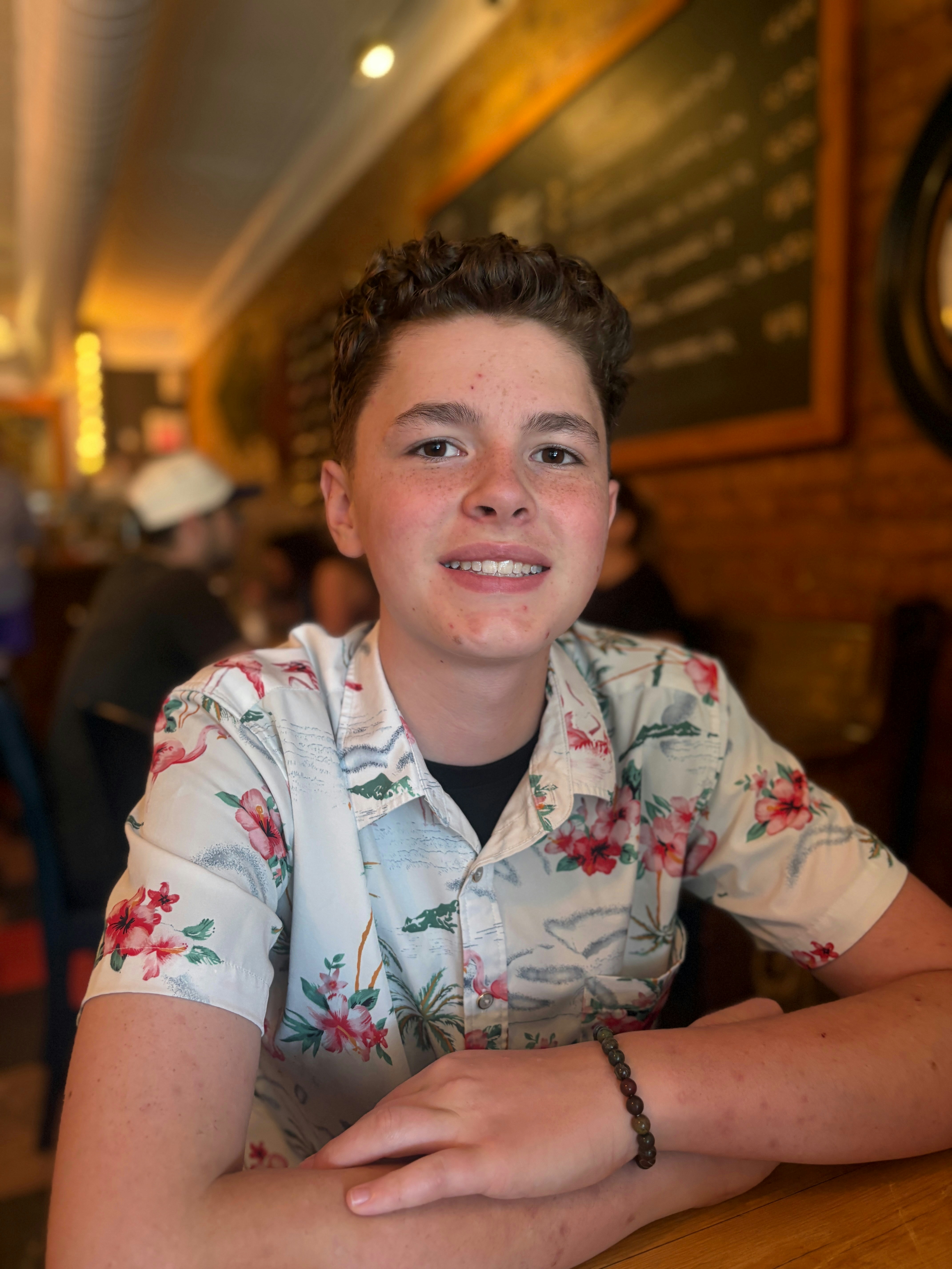 Floral Shirt, Friendly Focus: A Casual Portrait in a Warm Café