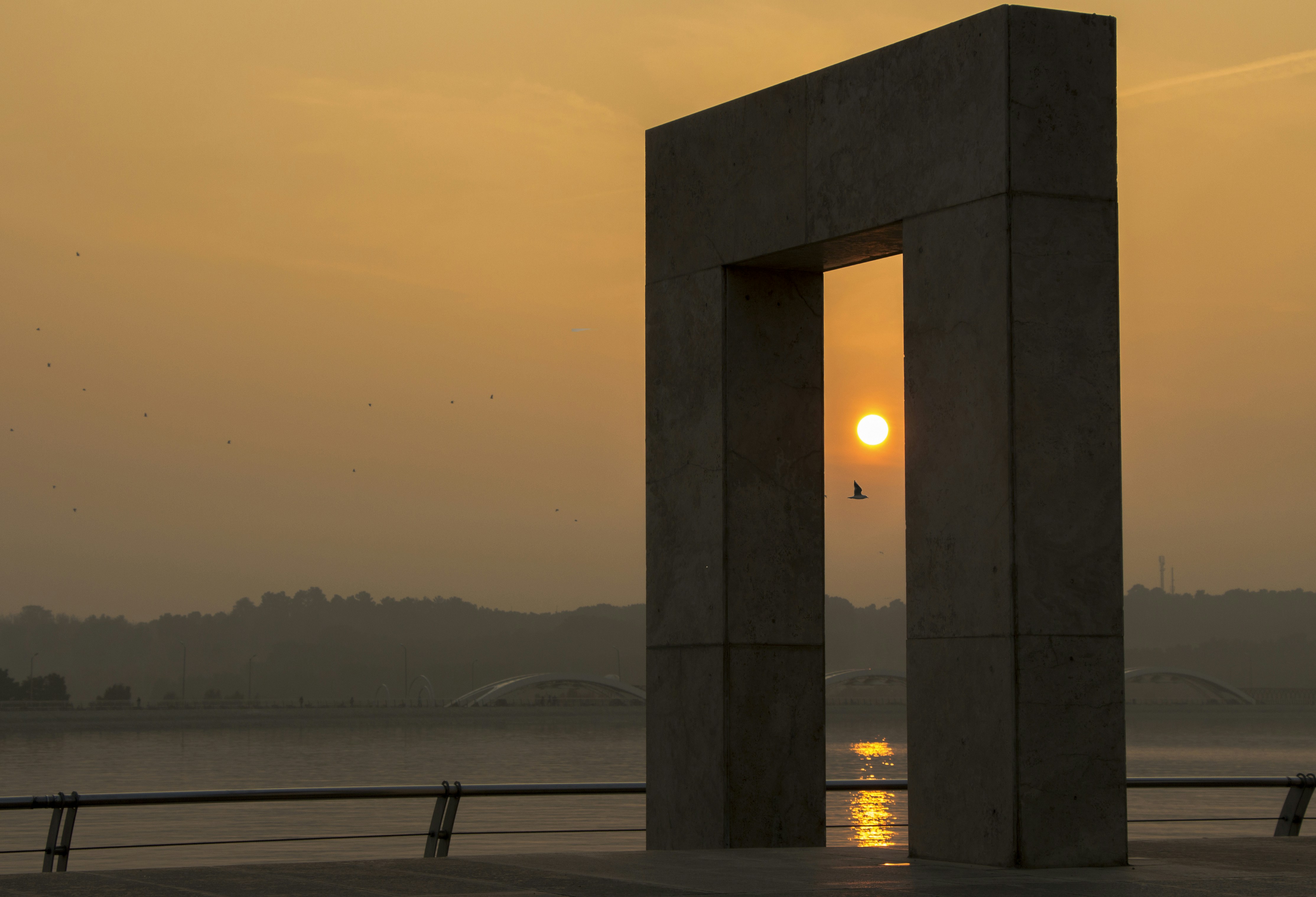Sun Through a Concrete Gateway: A Quiet Dusk at the Riverside