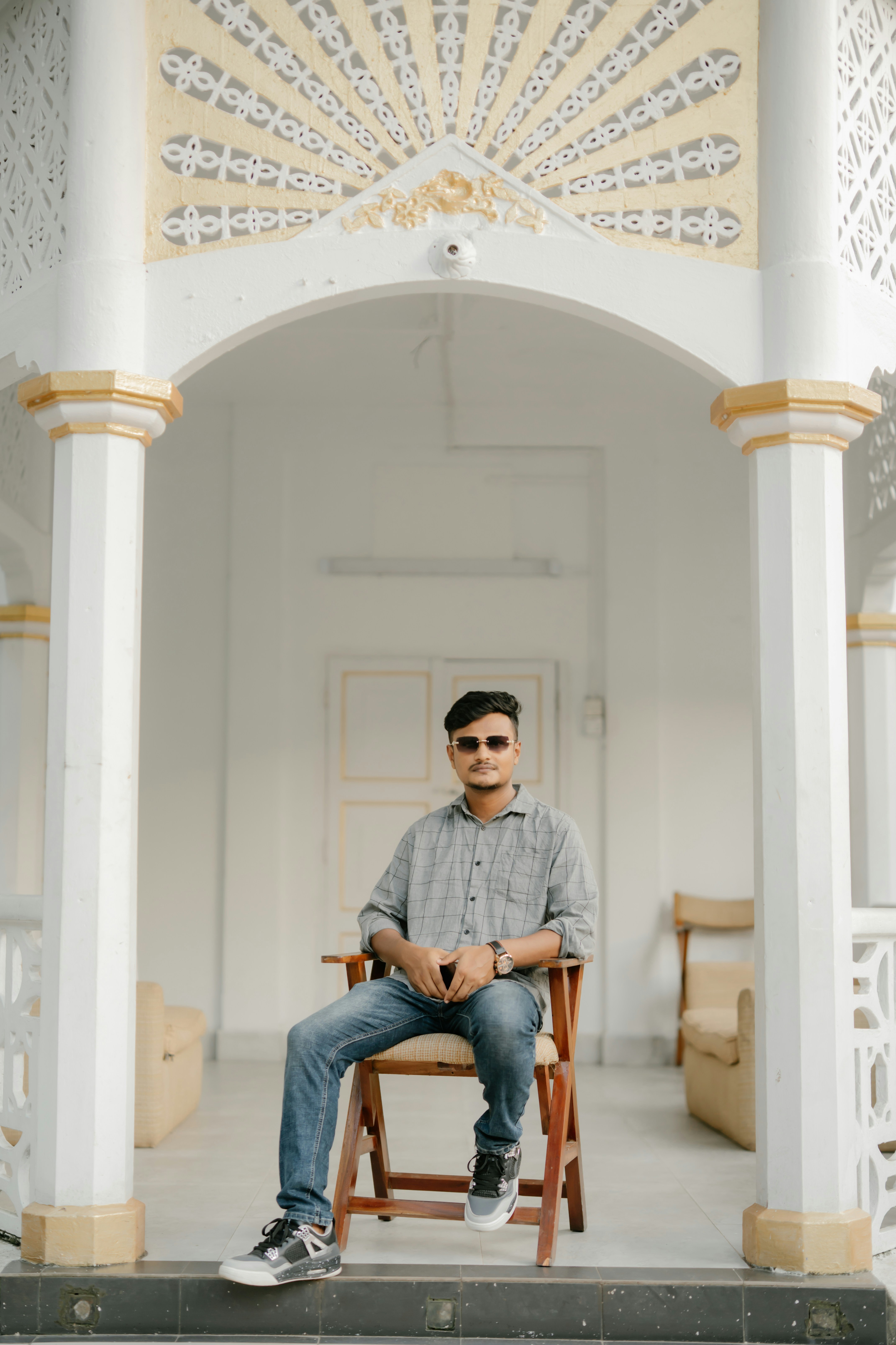 Sitting in Symmetry: A Quiet Portrait beneath Ornate Arches