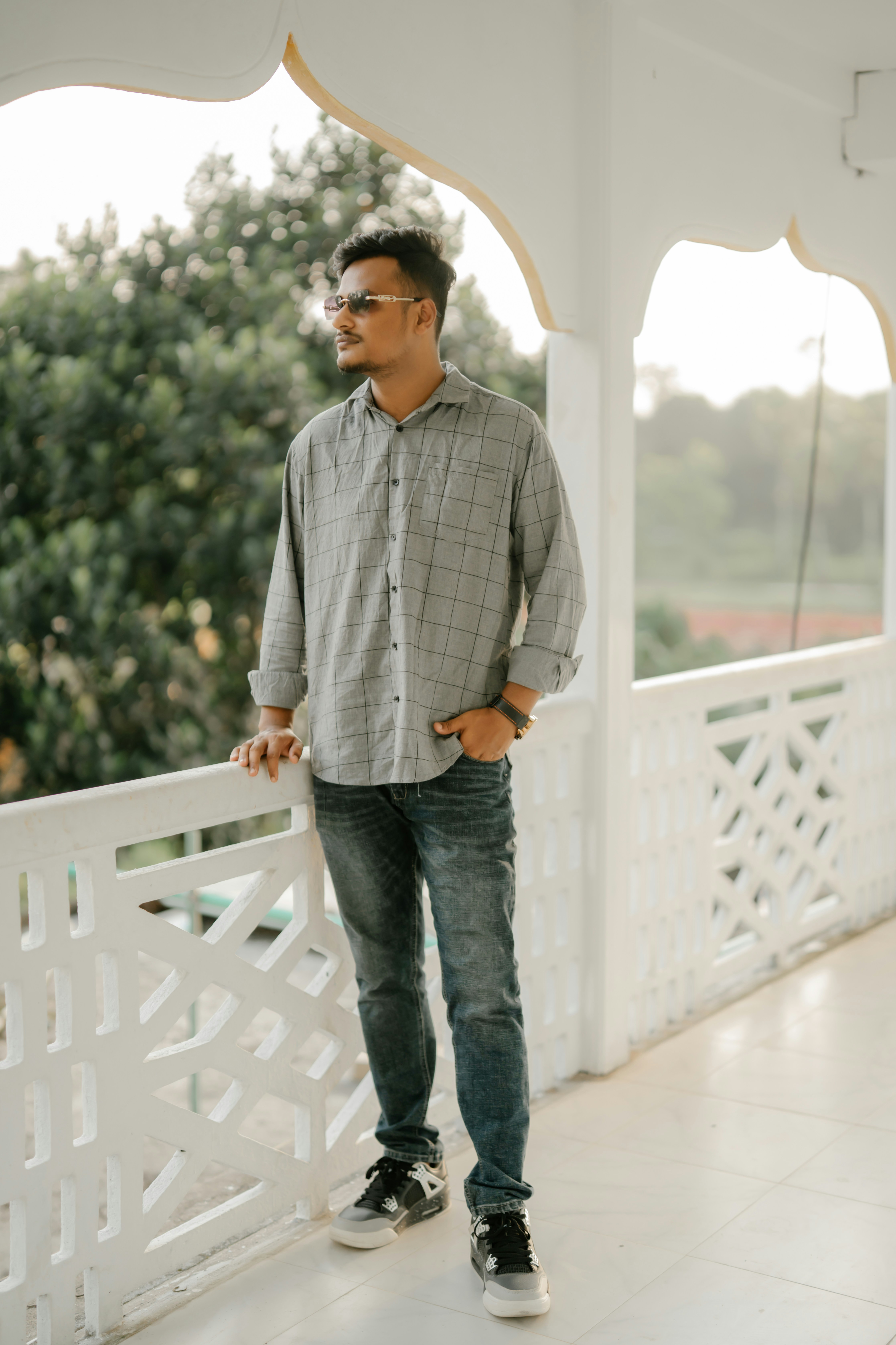 Casual Portrait on a Daylit Veranda with Geometric Railings