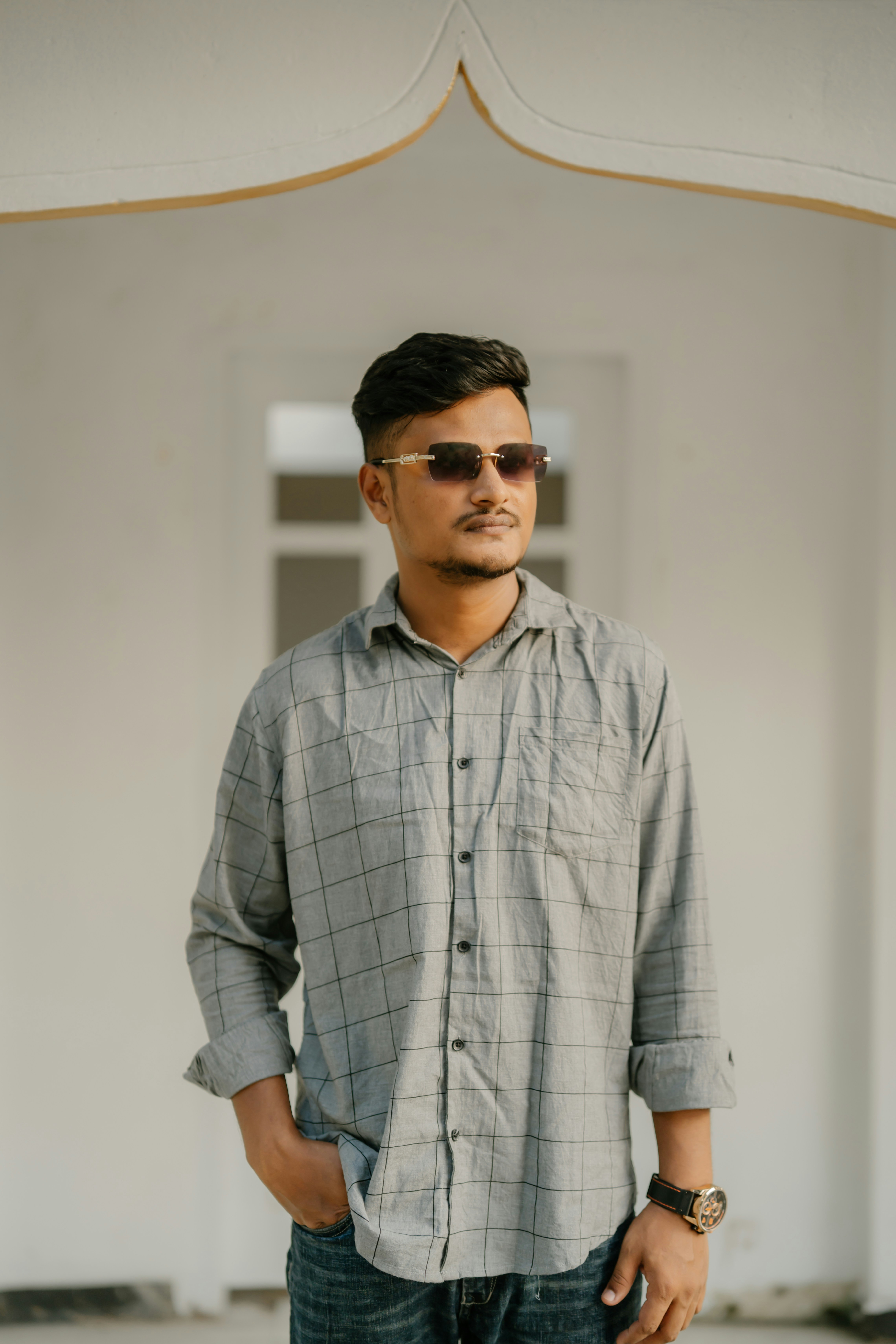 Midday Confidence: A Gentleman in Grid-Checked Shirt and Sunglasses