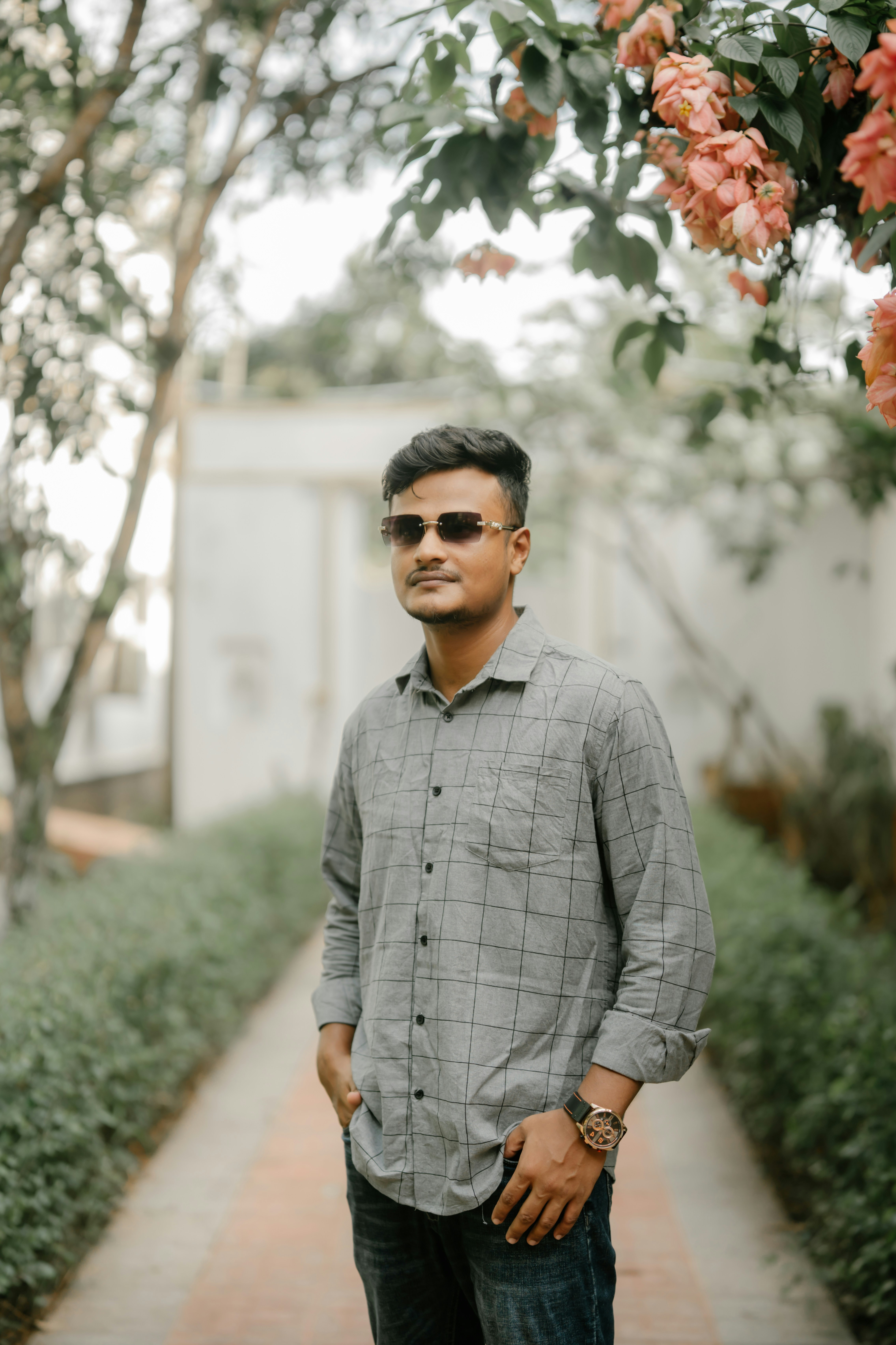 Portrait in Soft Focus: Man in Plaid Shirt Under Floral Canopy