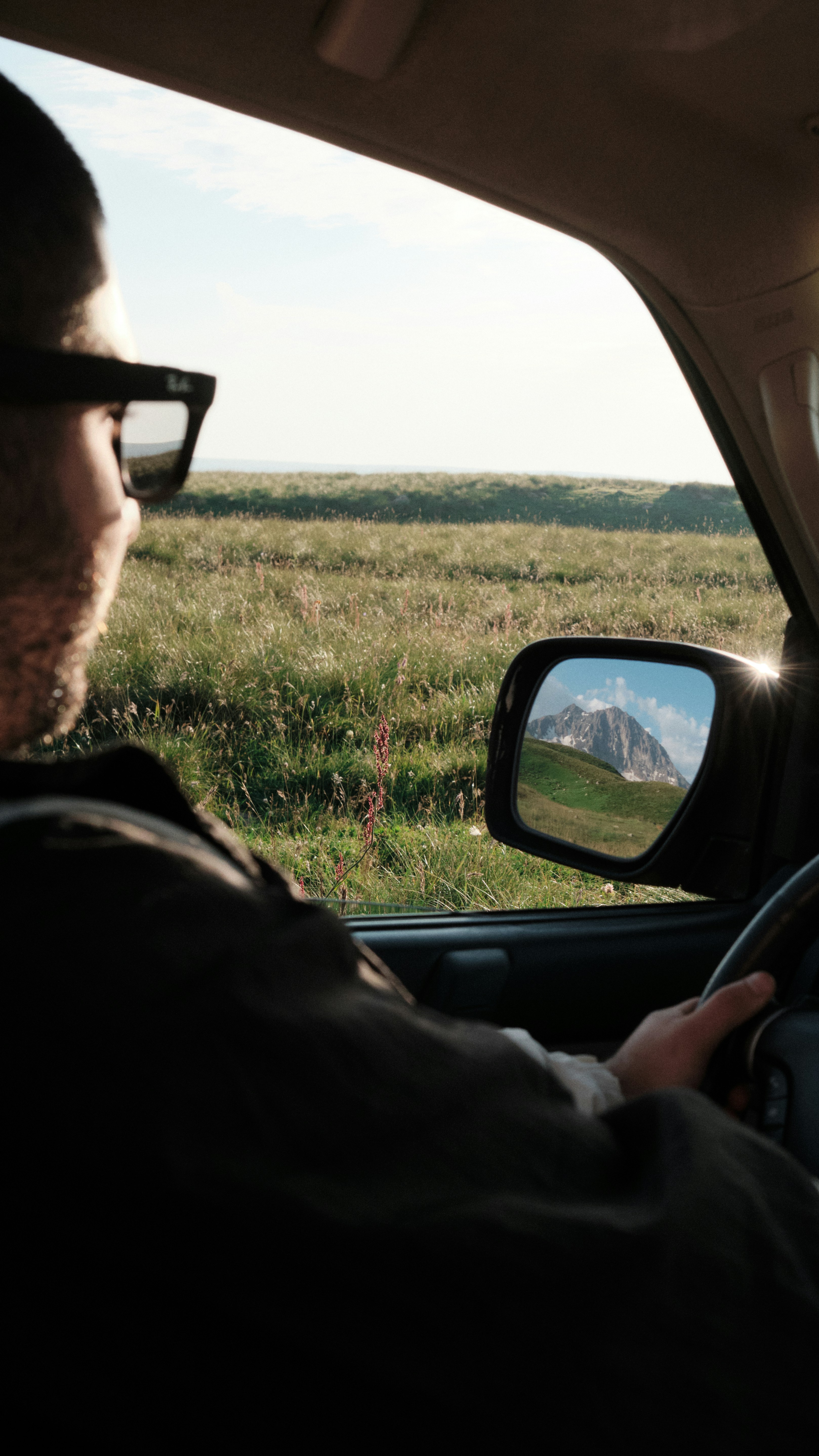 Driver’s View: Open Field Reflections in a Quiet Car Crossroads