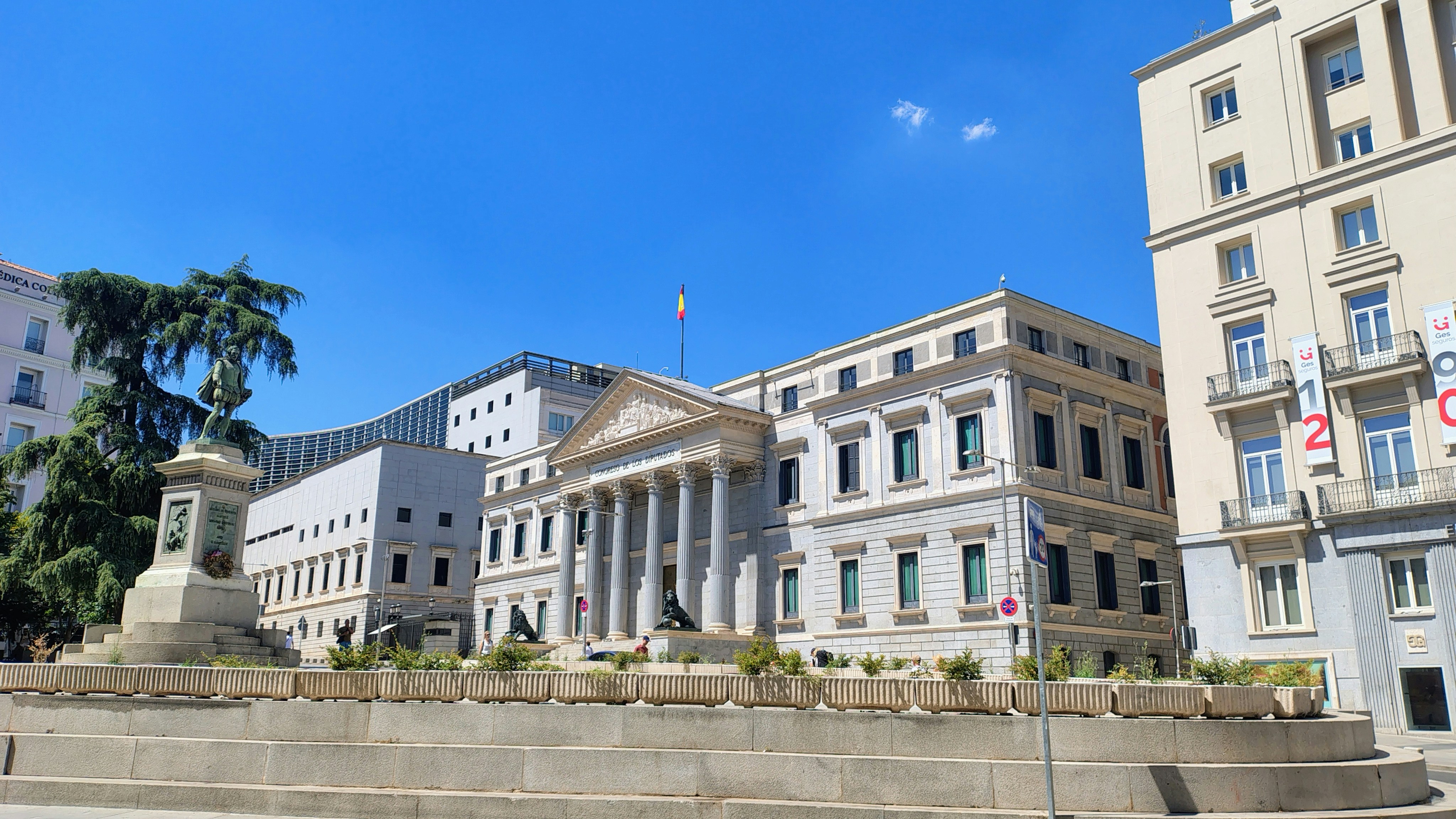 Neoclassical Steps: City Hall perched under a bright Madrid-blue sky