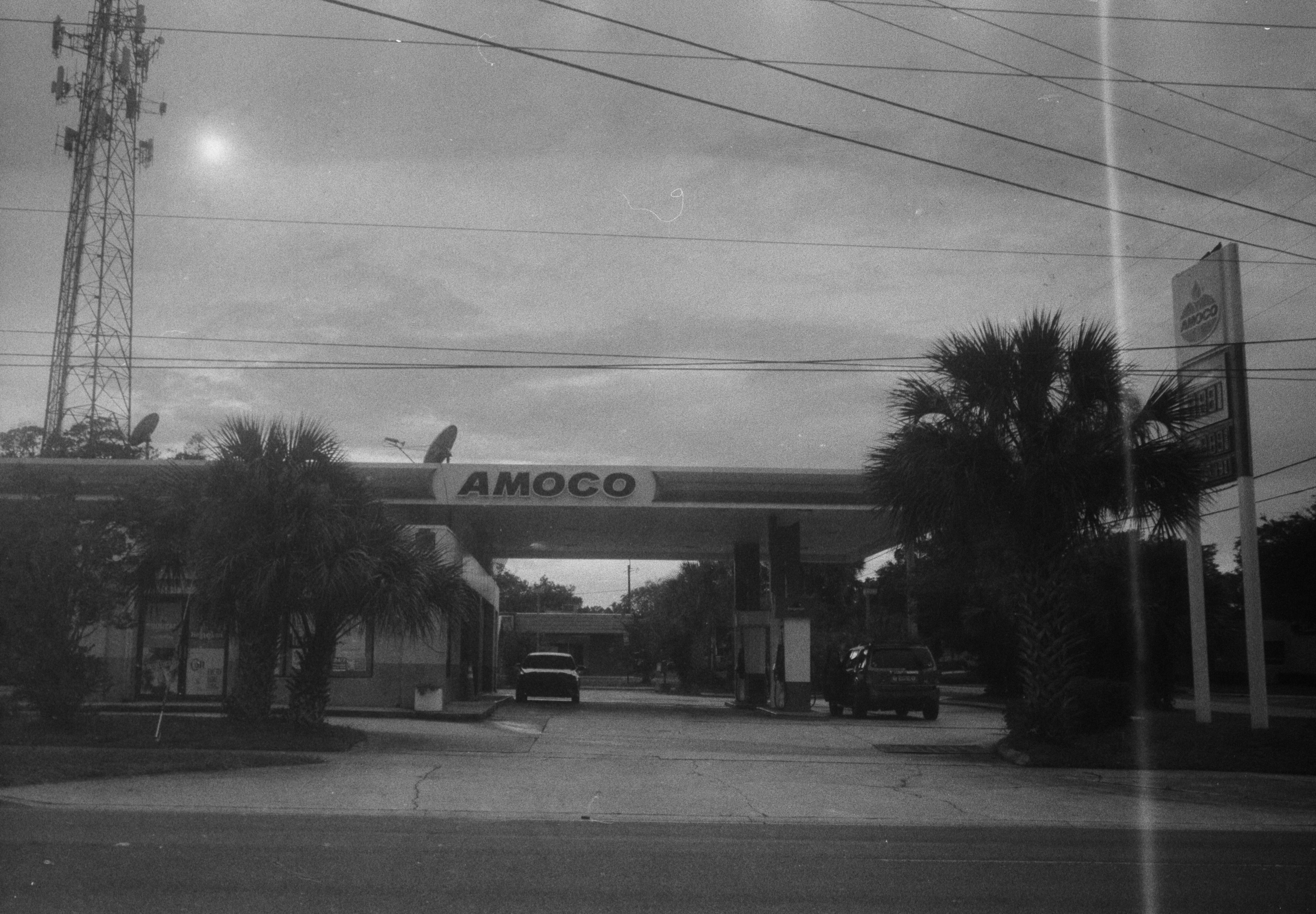 Amoco Canopy: Gas Station Through a Narrow Palm Corridor