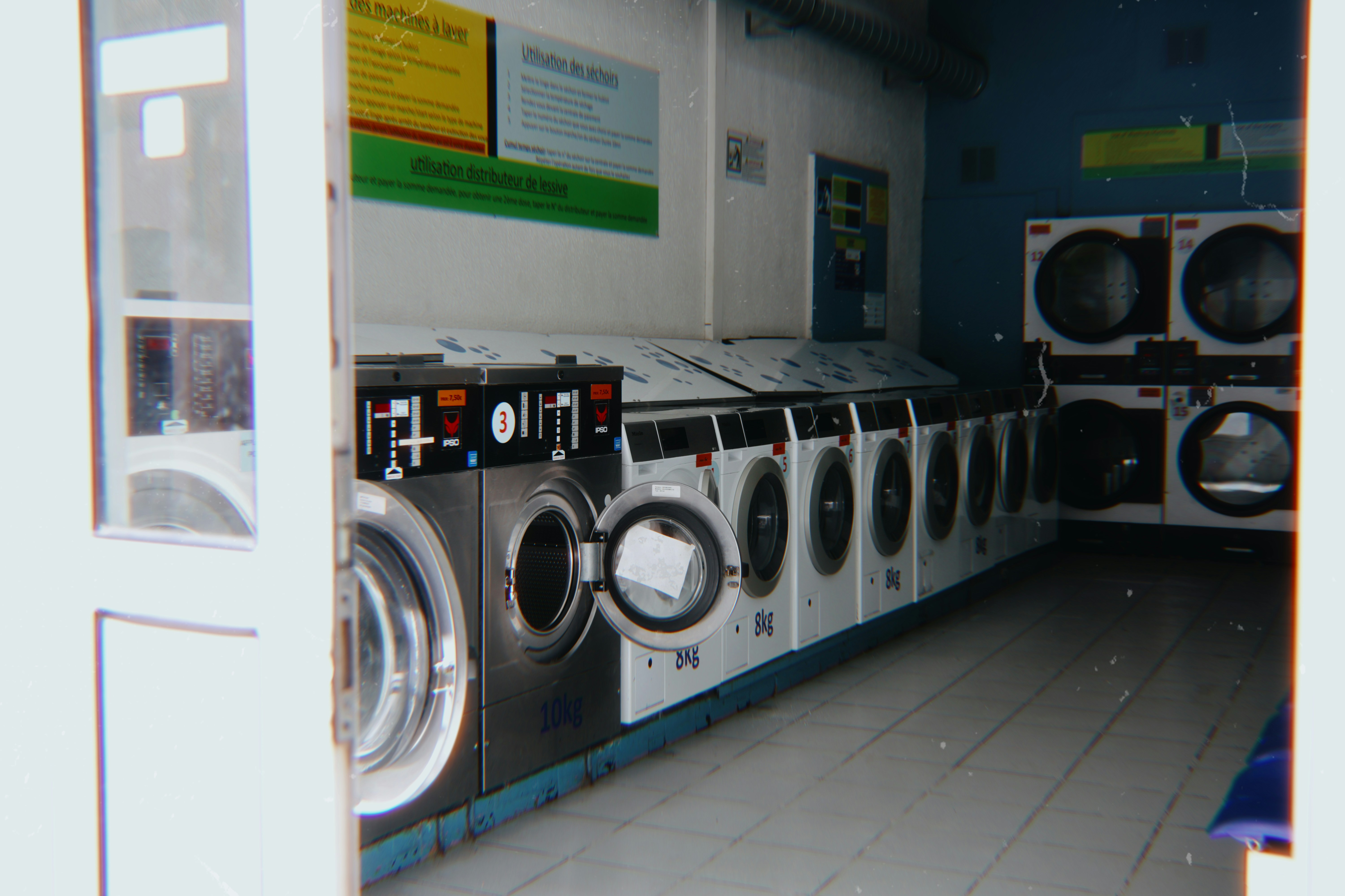Winds of Laundry: A Row of Commercial Washers in a Quiet Backroom
