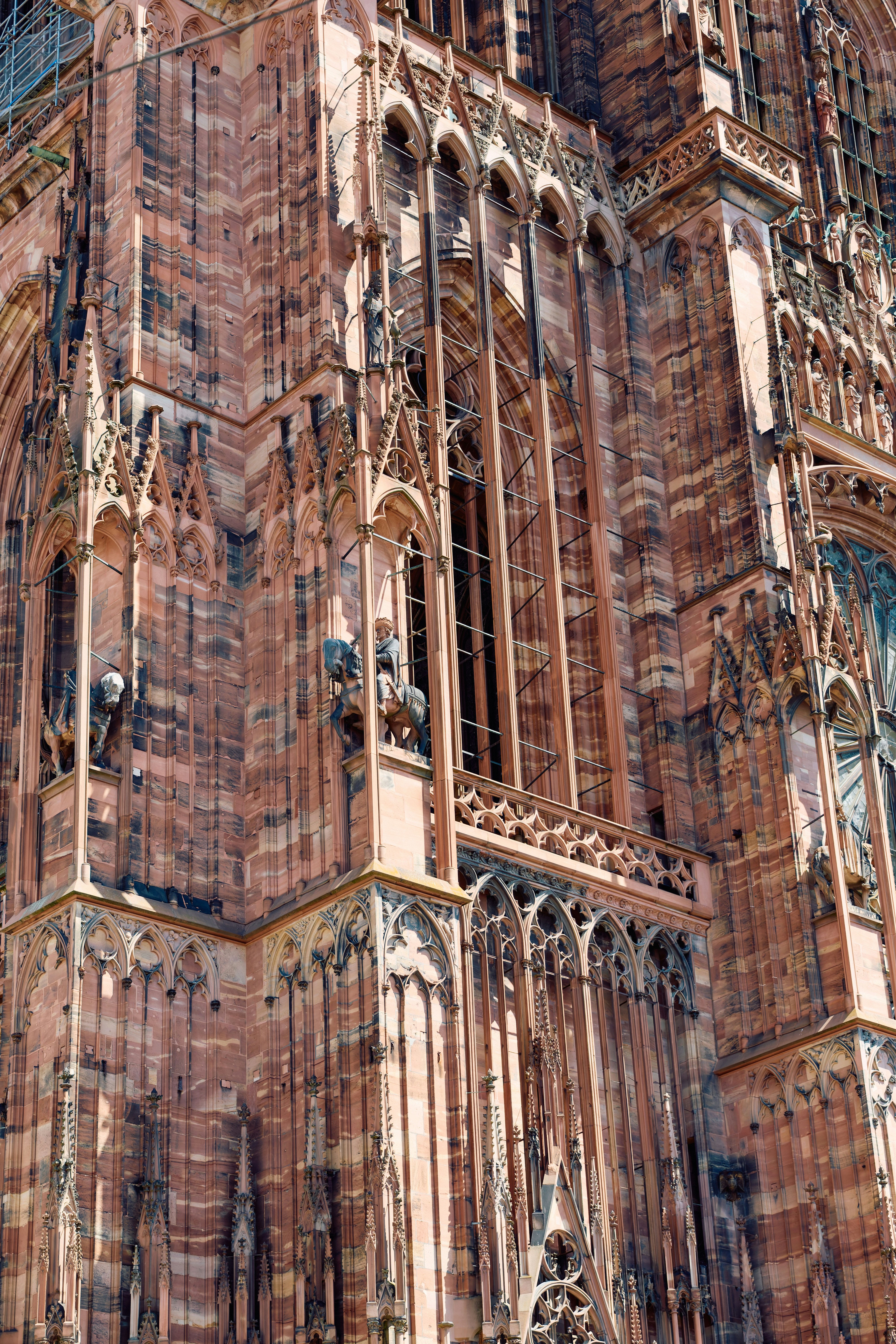 Gothic Facade: Stone Carvings and Arched Windows in Warm Light