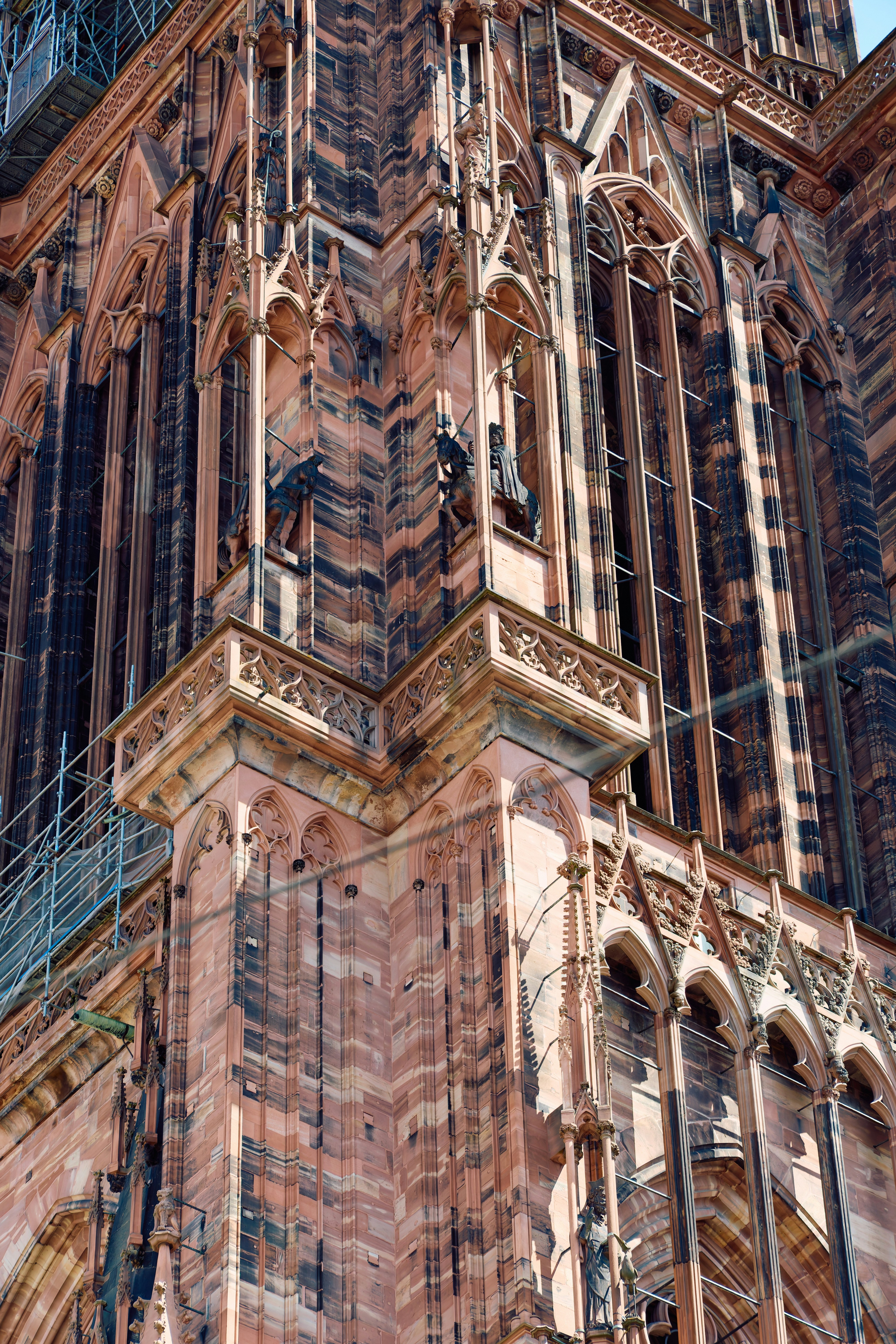Gothic Facade in Red Sandstone Rising Along Scaffolding